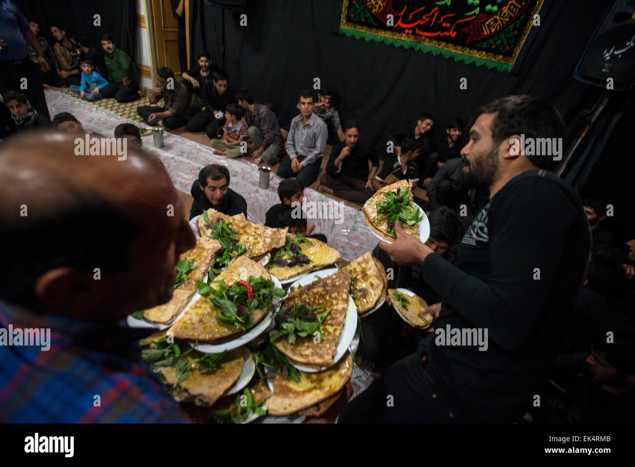 Participants of Tazieh, ritual theater of the day of Ashura, eat beryun ...