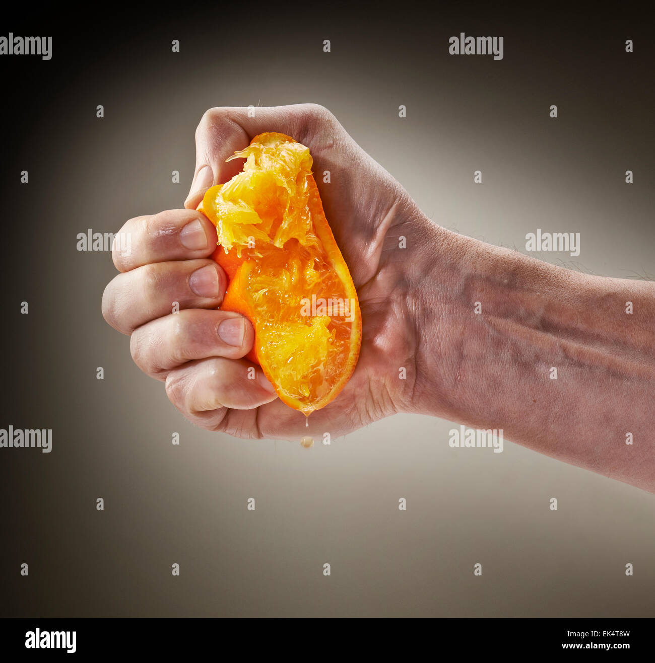 Fresh Squeezed Orange Juice by male hand and juice falling Stock Photo ...
