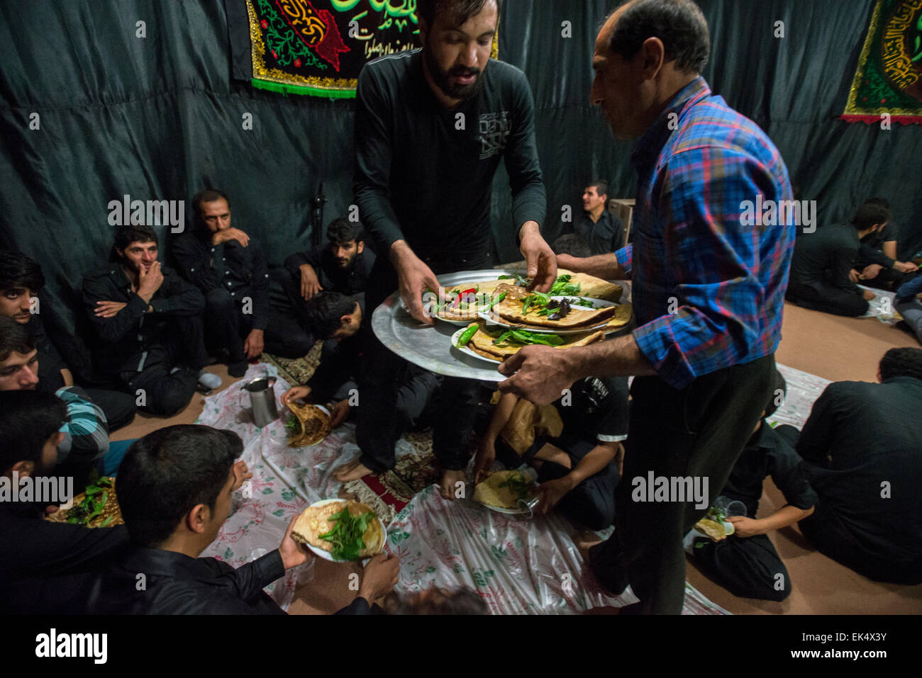Participants of Tazieh, ritual theater of the day of Ashura, eat beryun ...