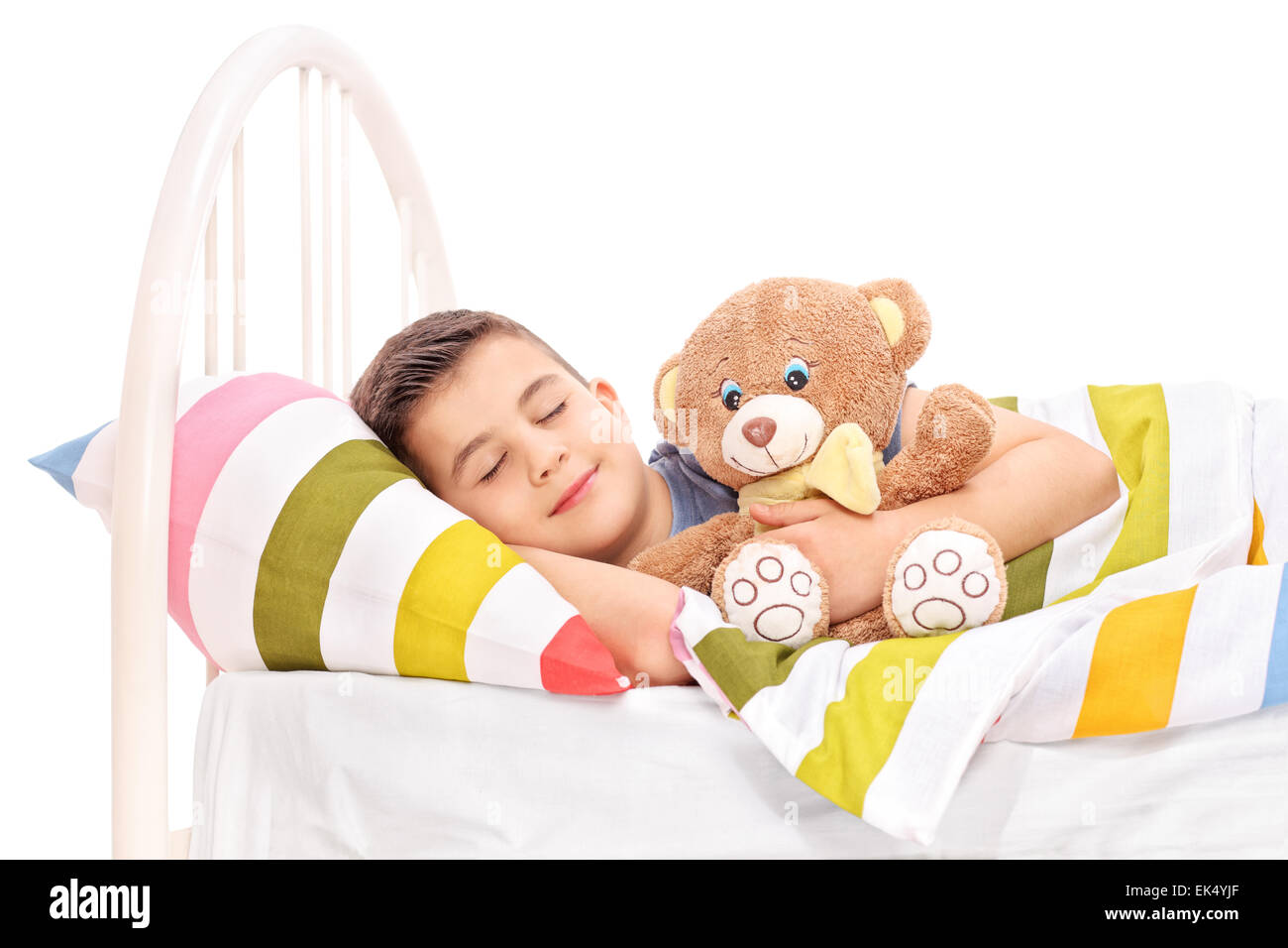 Cute little kid sleeping with a teddy bear covered with a blanket in ...