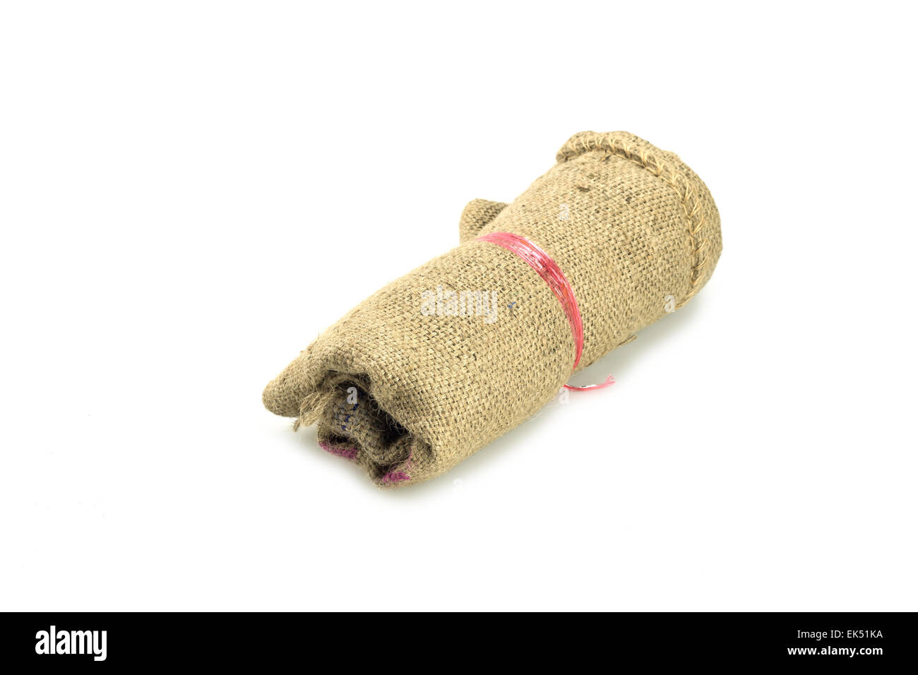 Roll of old sack or crumpled burlap isolated on white Stock Photo - Alamy