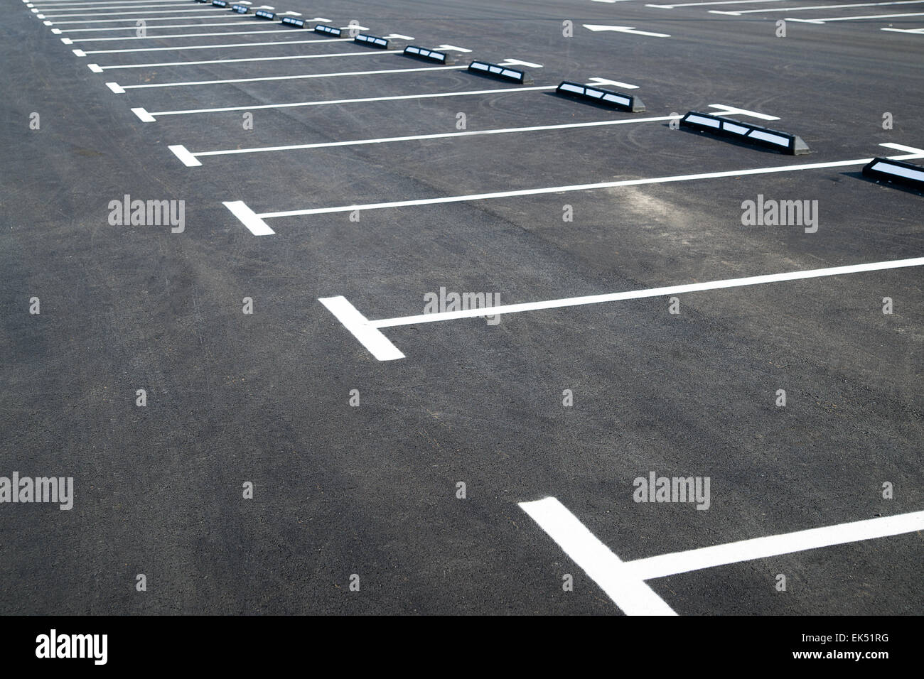 Markings on asphalt pavement indicating the parking lot in front of the ...
