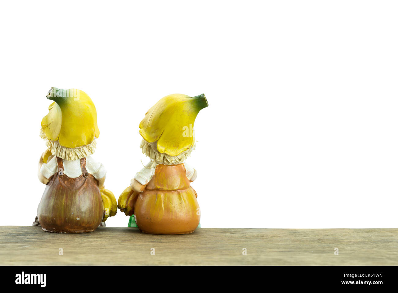 Two ceramic doll sit on wood, isolated on white Stock Photo - Alamy