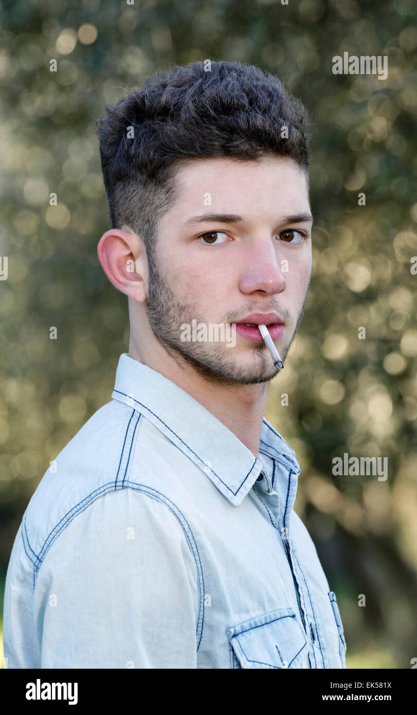 Italy, smoking male teenager portrait Stock Photo - Alamy