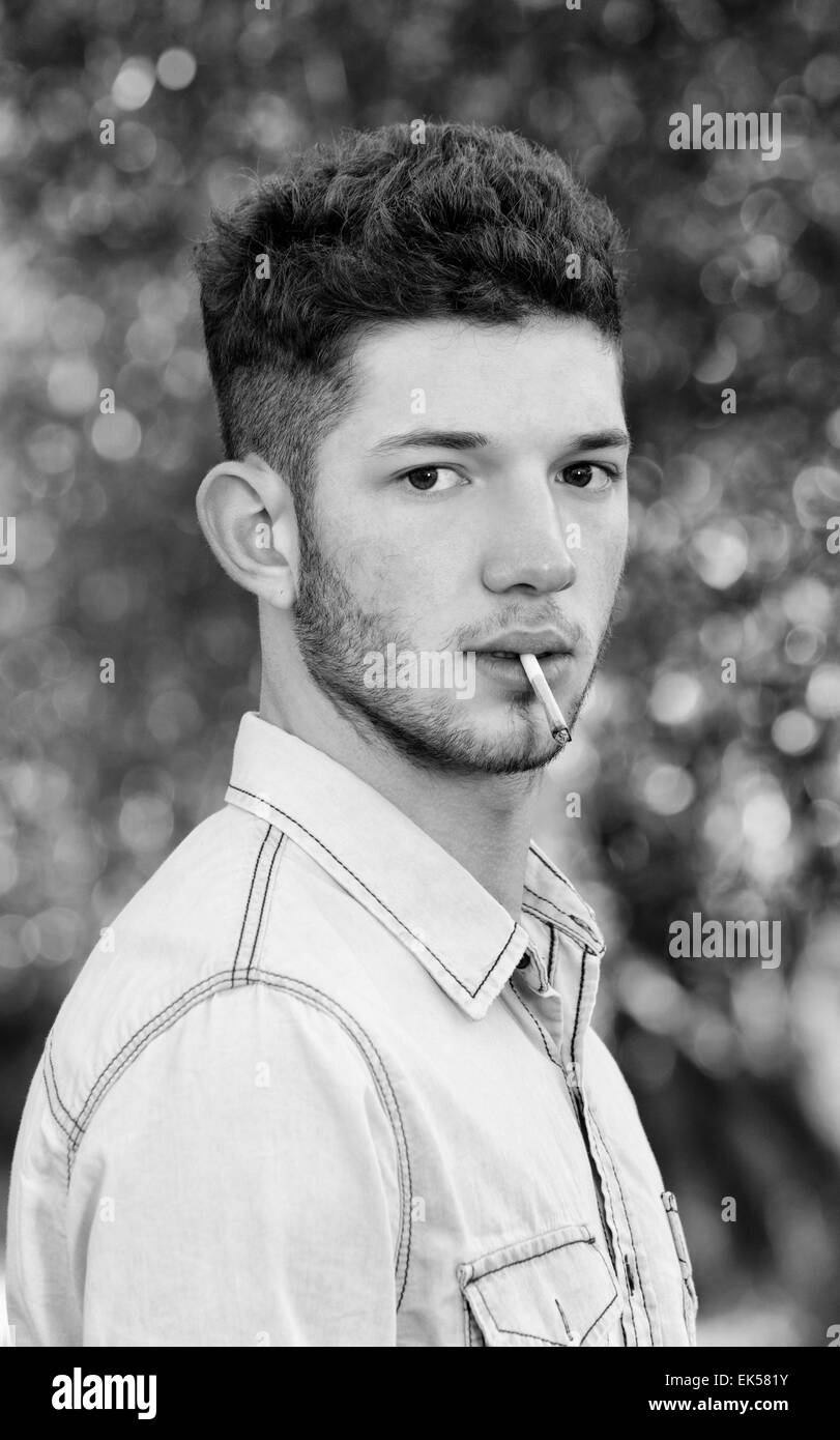 Italy, smoking male teenager portrait Stock Photo - Alamy