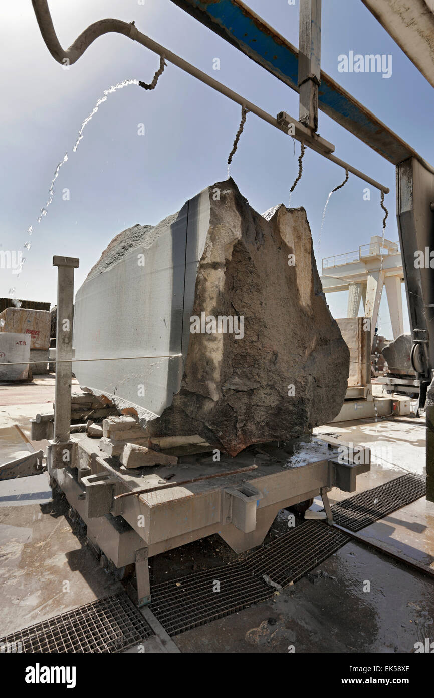Italy, marble cutting factory, granite block cooled with water while ...