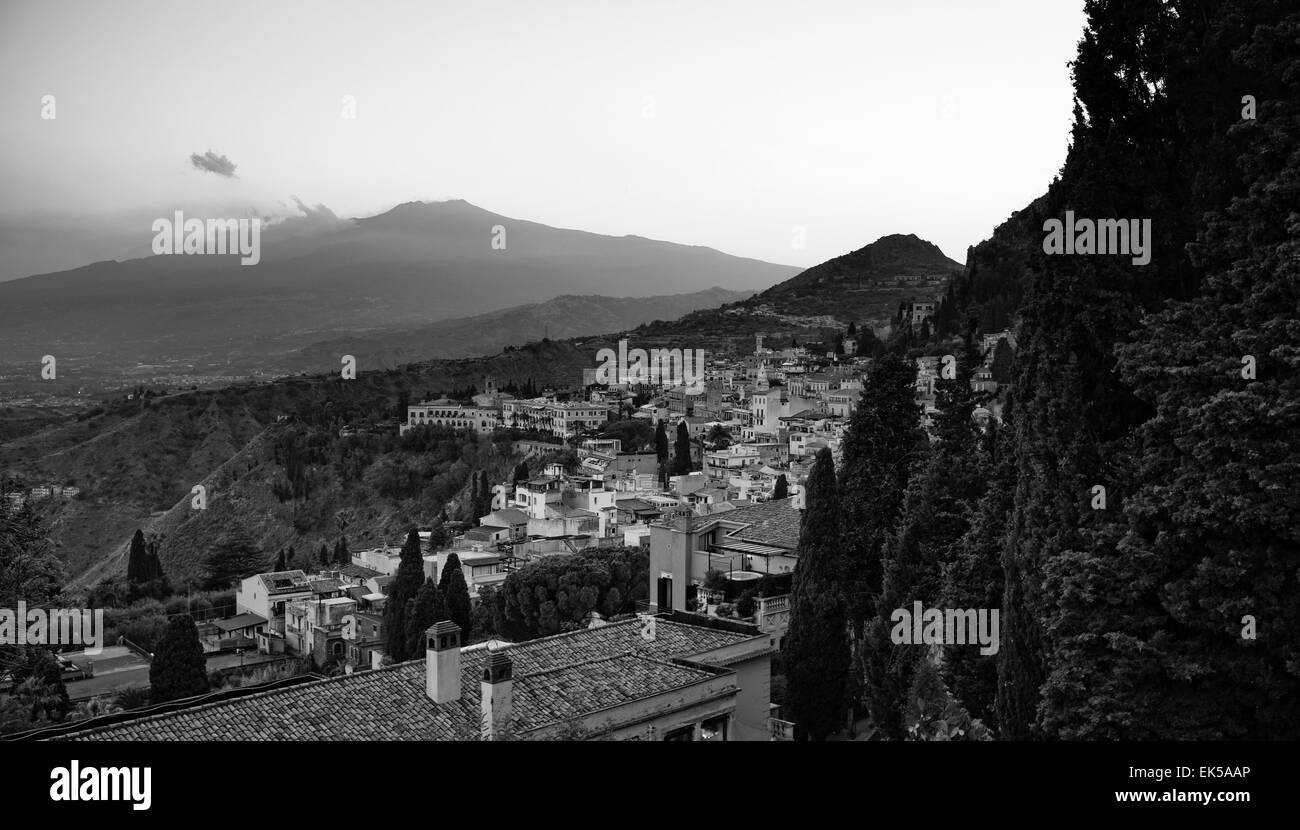 Italy, Sicily, Taormina, view of the town and Etna volcano at sunset ...