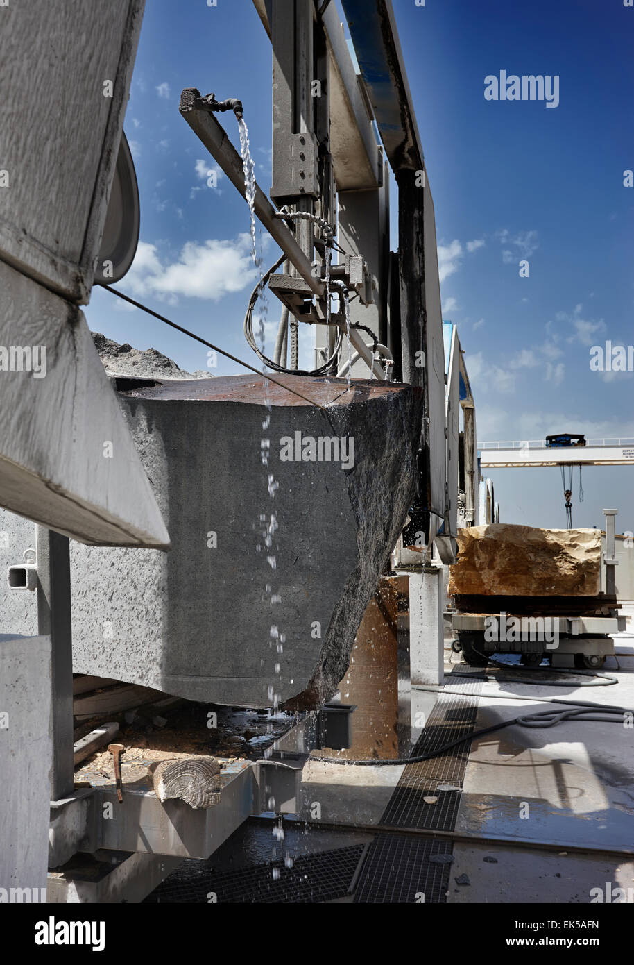 Italy, marble cutting factory, granite block cooled with water while ...