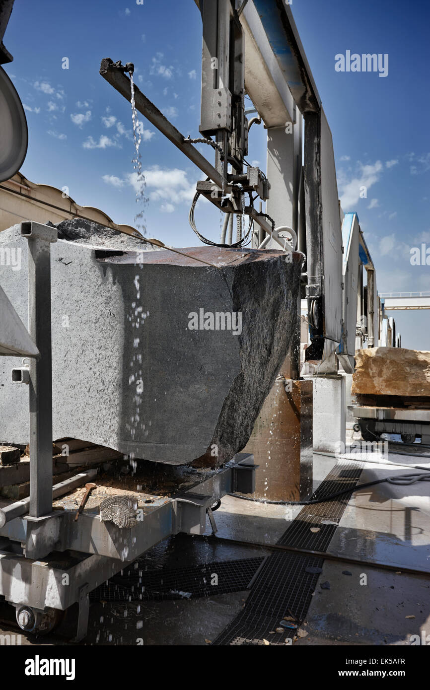 Italy, marble cutting factory, granite block cooled with water while ...