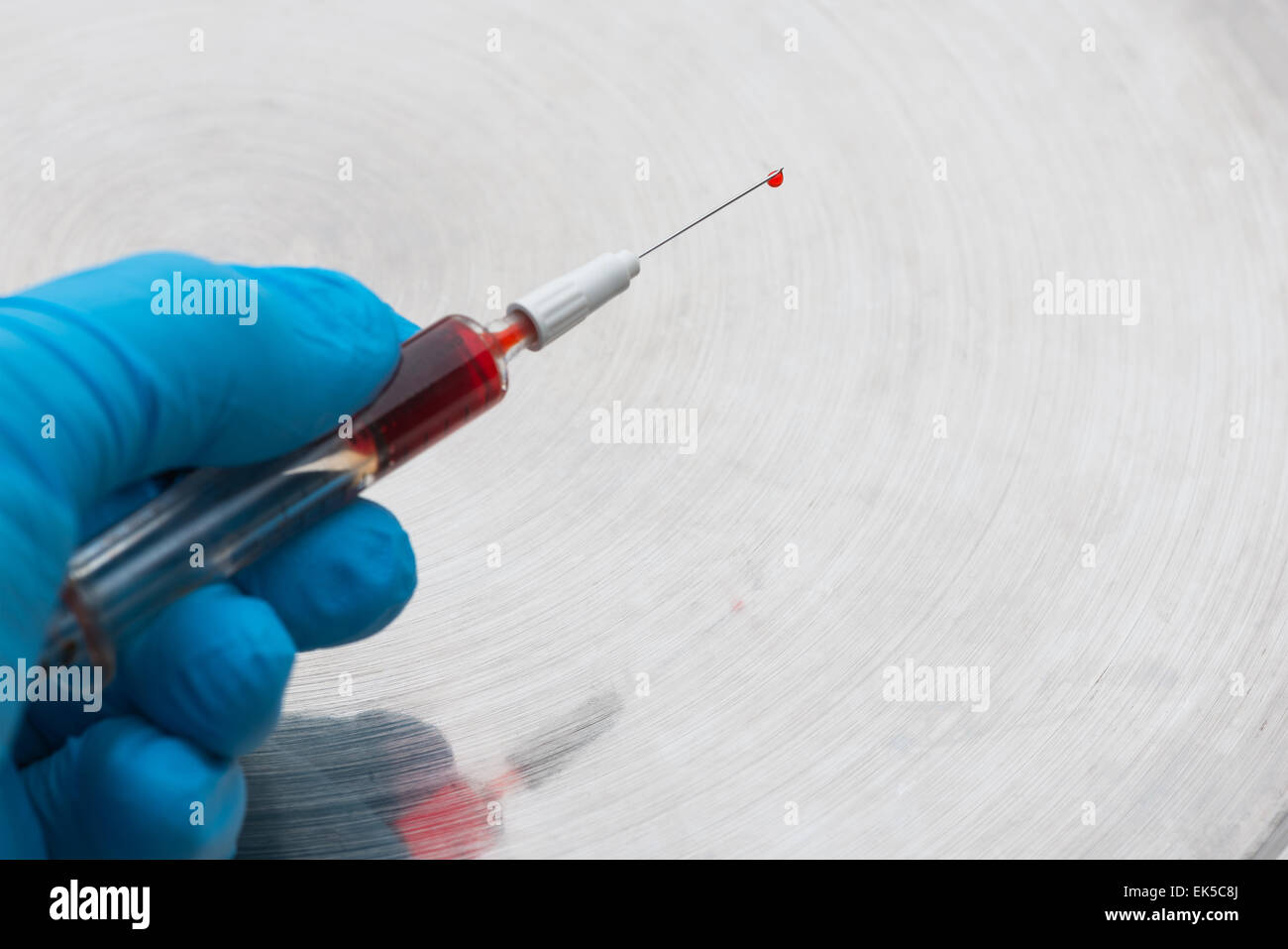 suggestive of body fluid and serum red liquid inside a syringe taken as ...