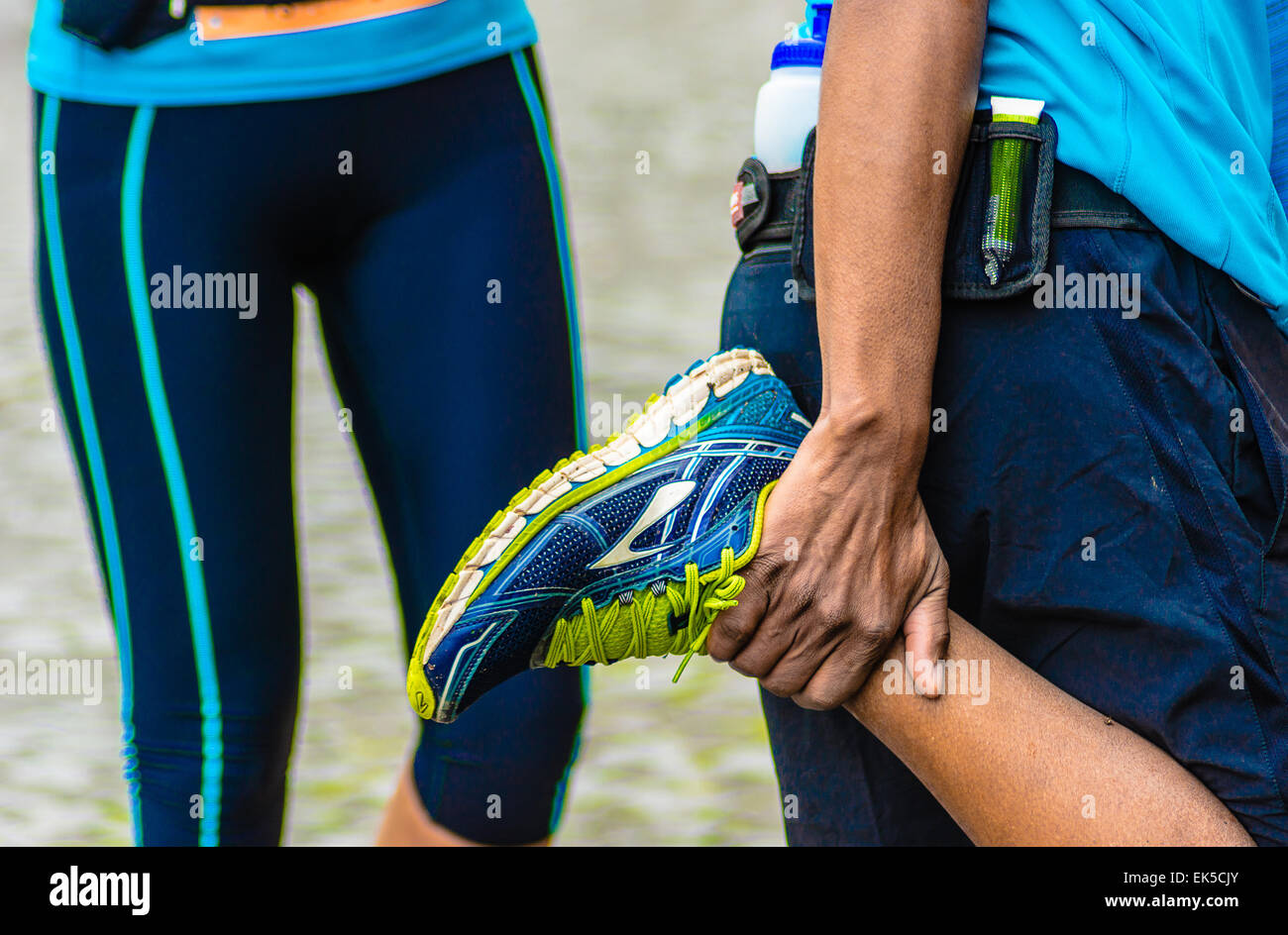 a runner caught stretching his right leg after a marathon Stock Photo ...