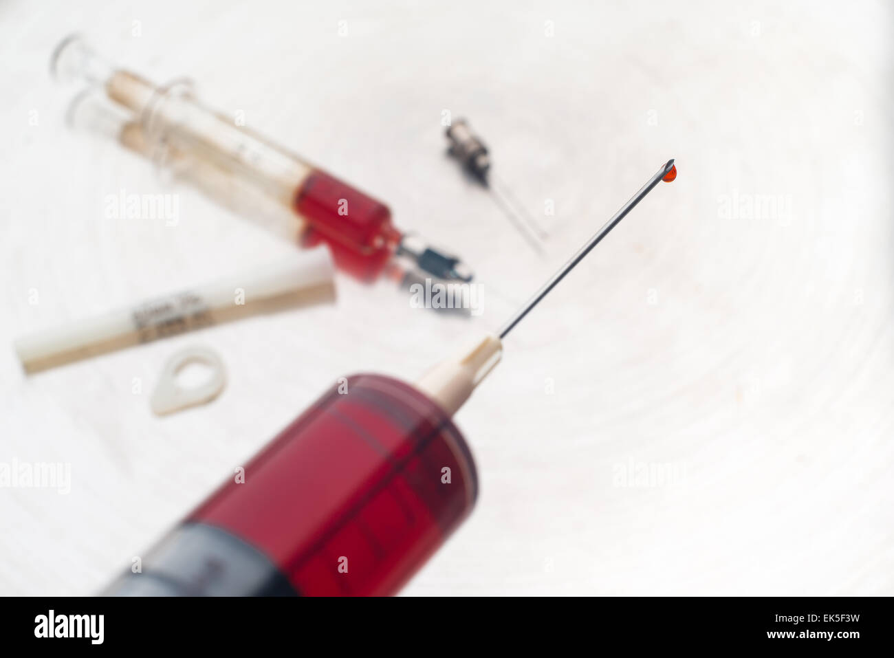 suggestive of body fluid and serum red liquid inside a syringe taken as ...