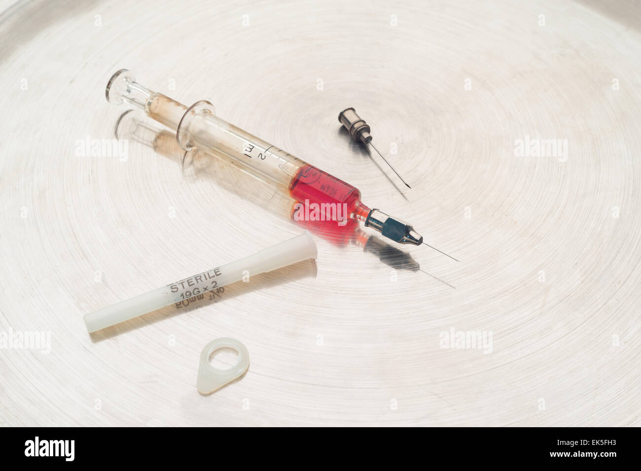 suggestive of body fluid and serum red liquid inside a syringe taken as ...