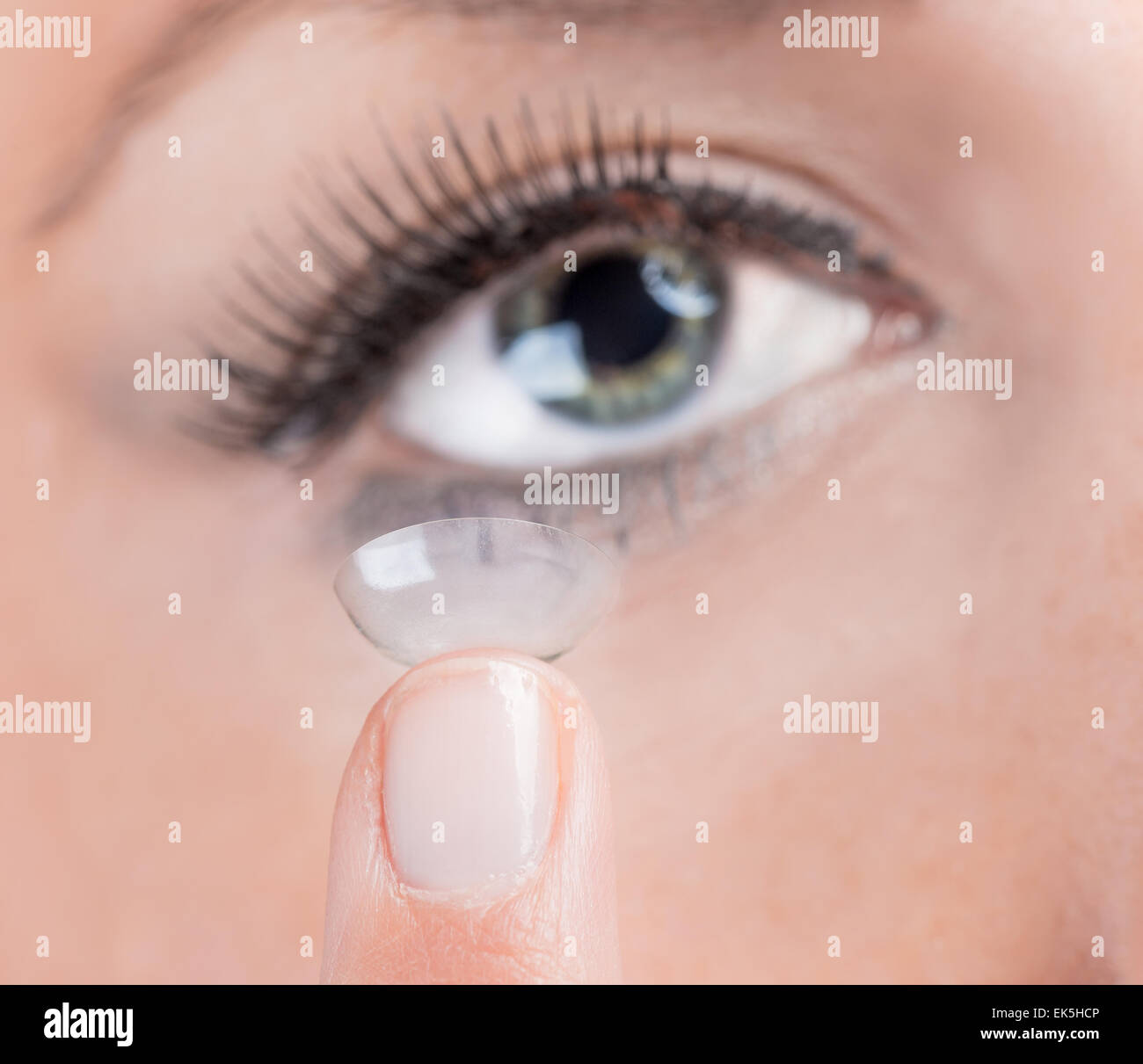 Young woman Inserting a contact lens, close-up Stock Photo - Alamy