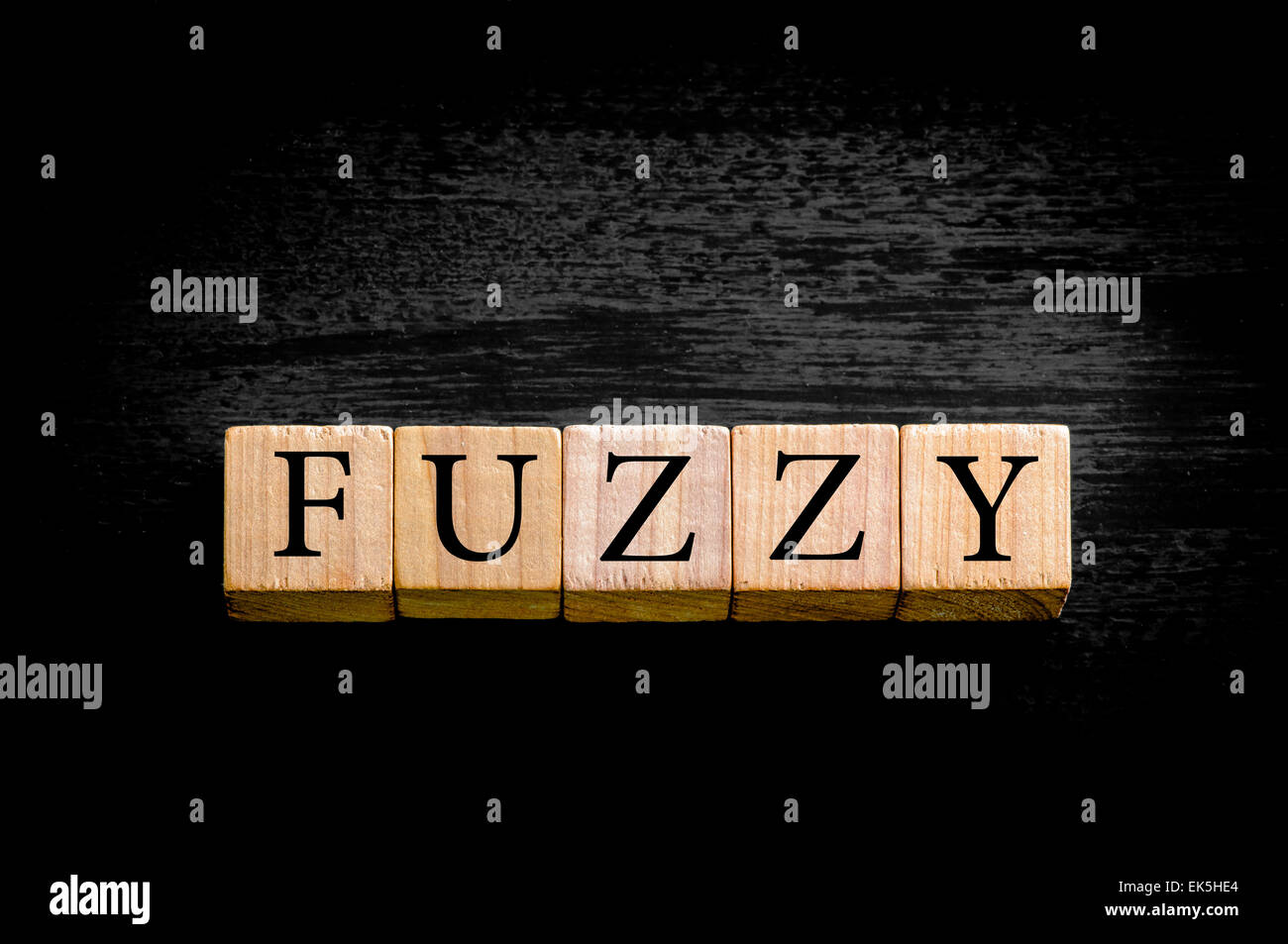 Word FUZZY. Wooden small cubes with letters isolated on black ...
