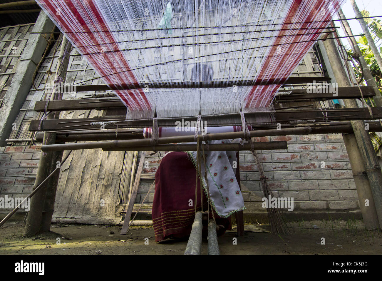 Sivasagar, Assam, India. 7th Apr, 2015. A woman weaves gamosa ...