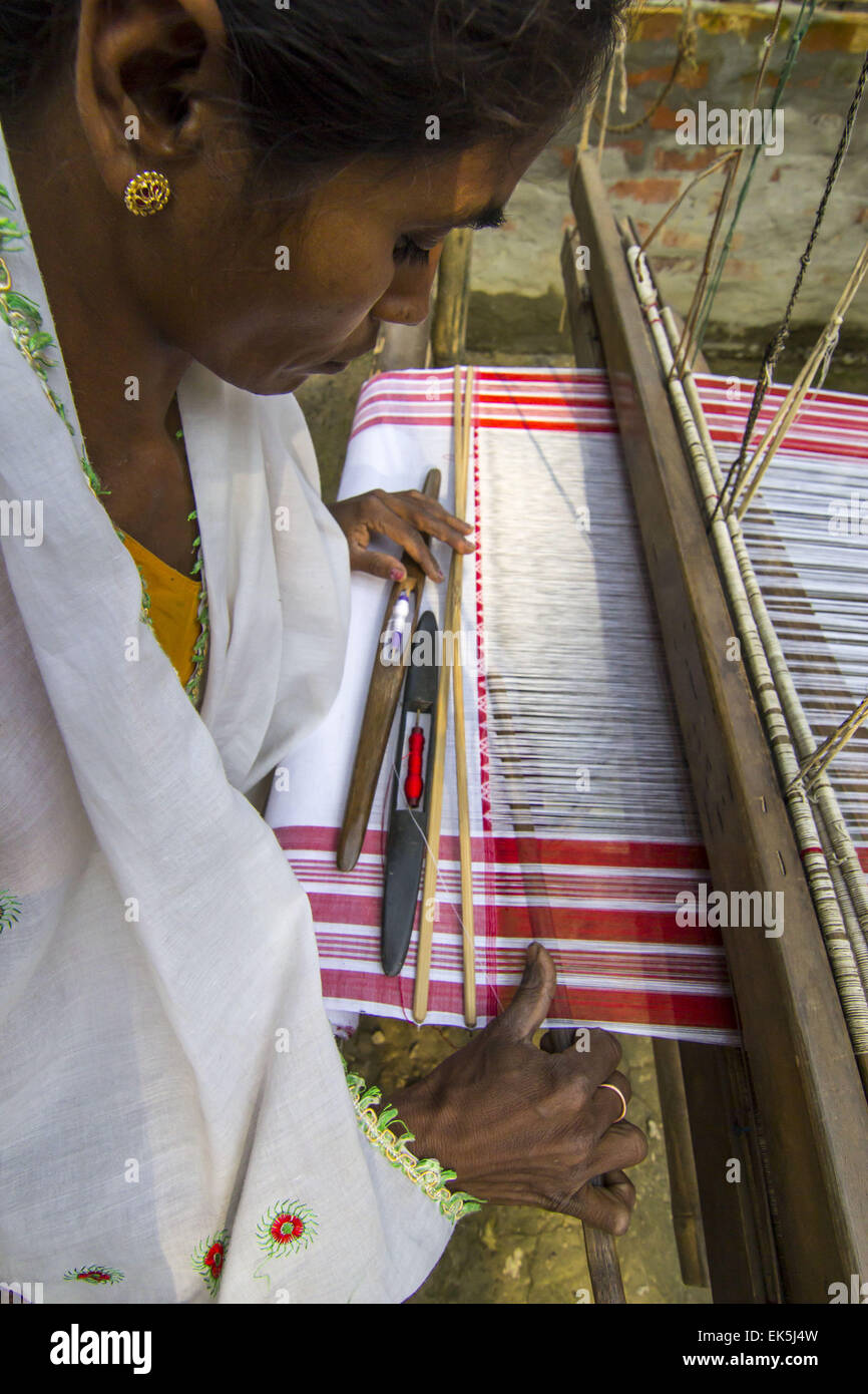Sivasagar, Assam, India. 7th Apr, 2015. A woman weaves gamosa ...