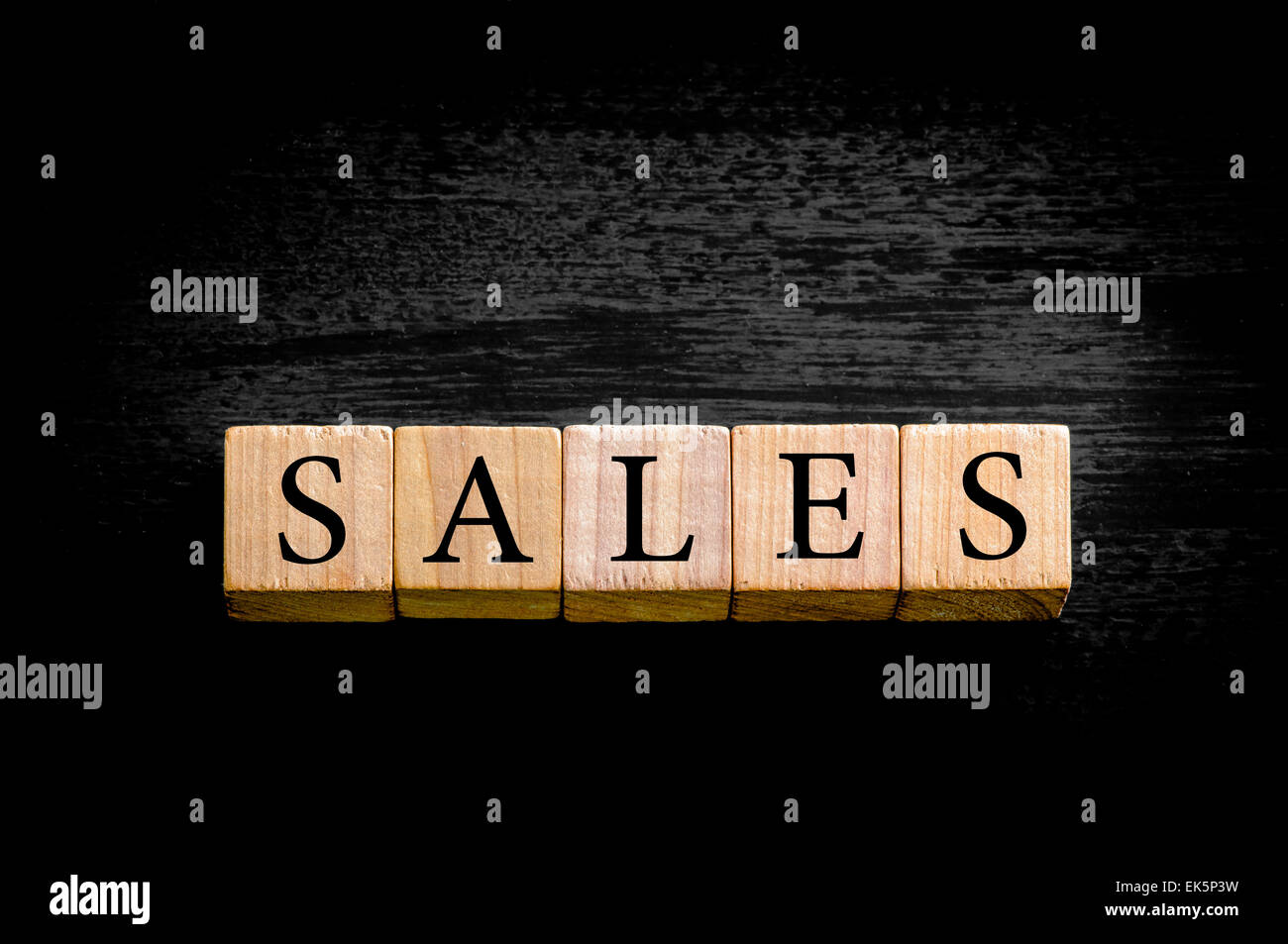Word SALES. Wooden small cubes with letters isolated on black ...