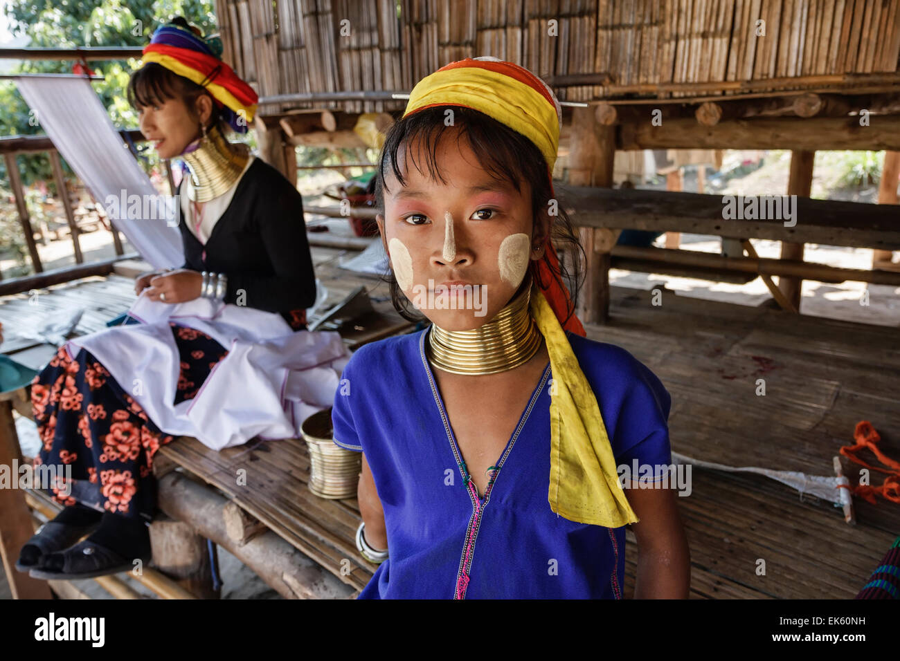 Thailand, Chang Mai, Karen Long Neck hill tribe village (Kayan Lahwi), young girl and her mother ...