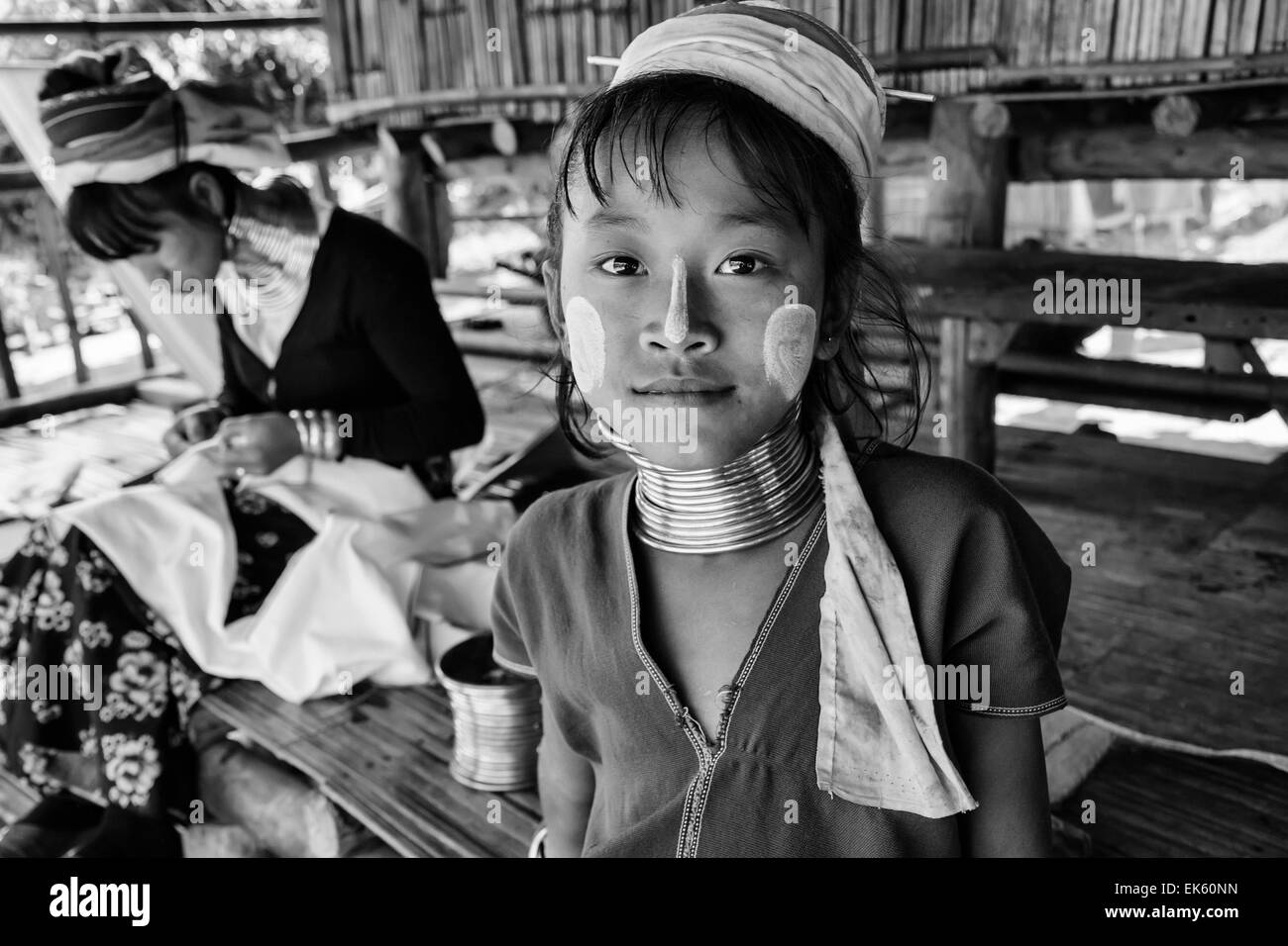 Thailand, Chang Mai, Karen Long Neck hill tribe village (Kayan Lahwi), young girl and her mother ...