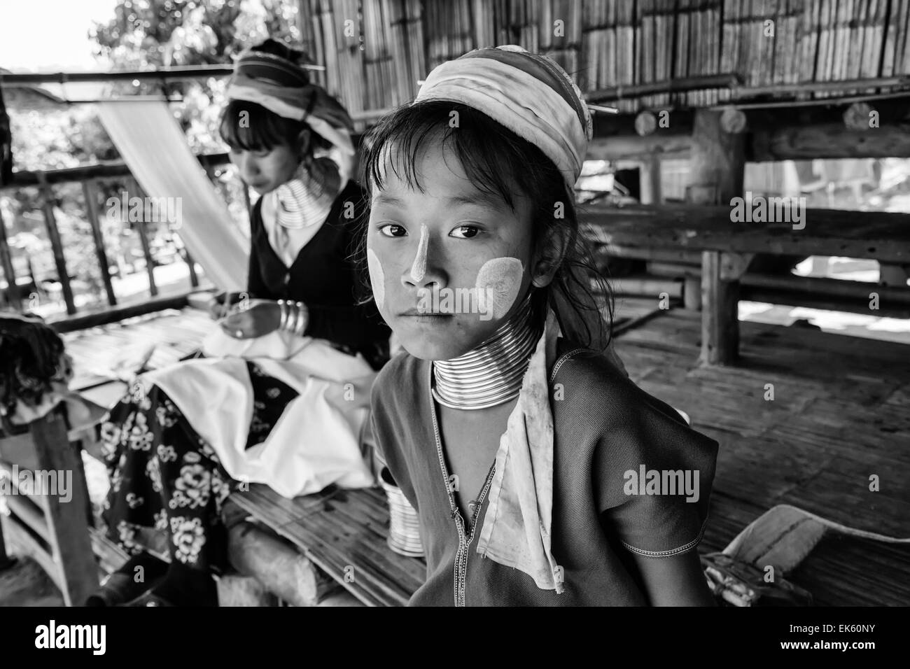 Thailand, Chang Mai, Karen Long Neck hill tribe village (Kayan Lahwi), young girl and her mother ...