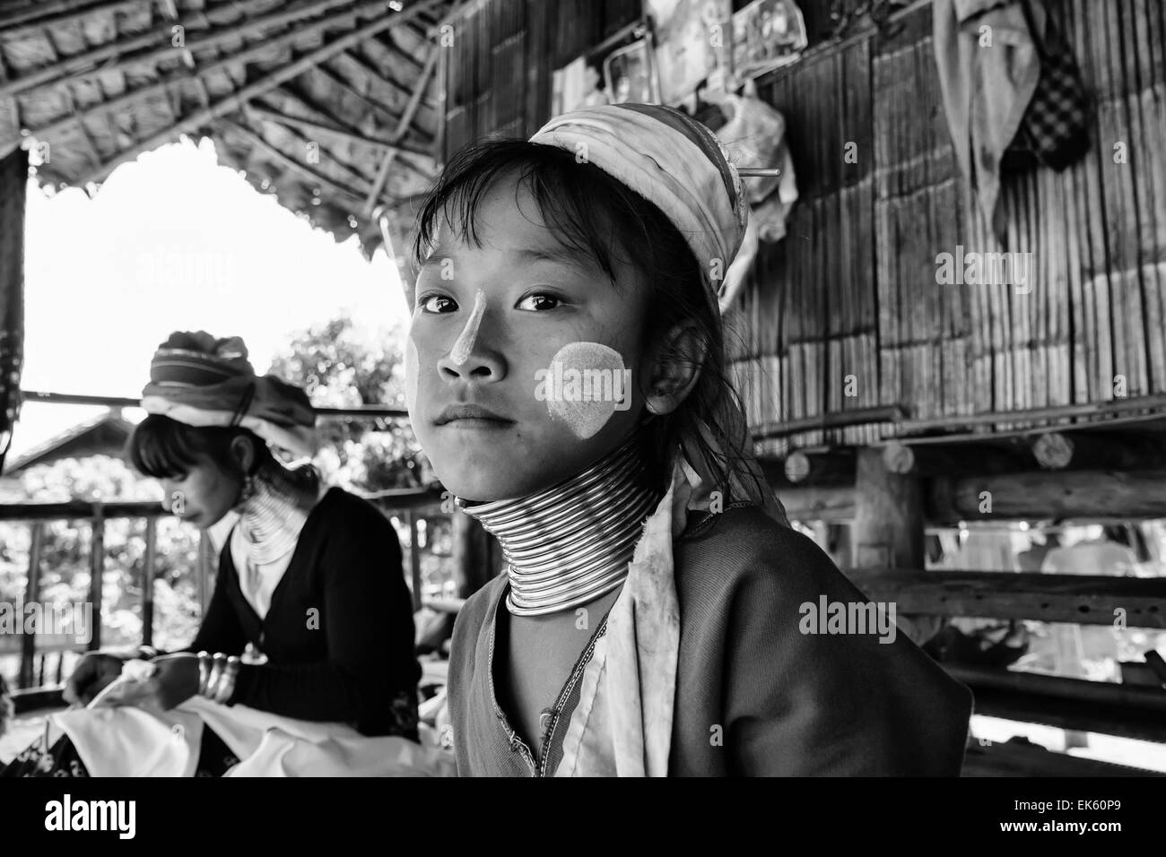 Thailand, Chang Mai, Karen Long Neck hill tribe village (Kayan Lahwi), young girl and her mother ...