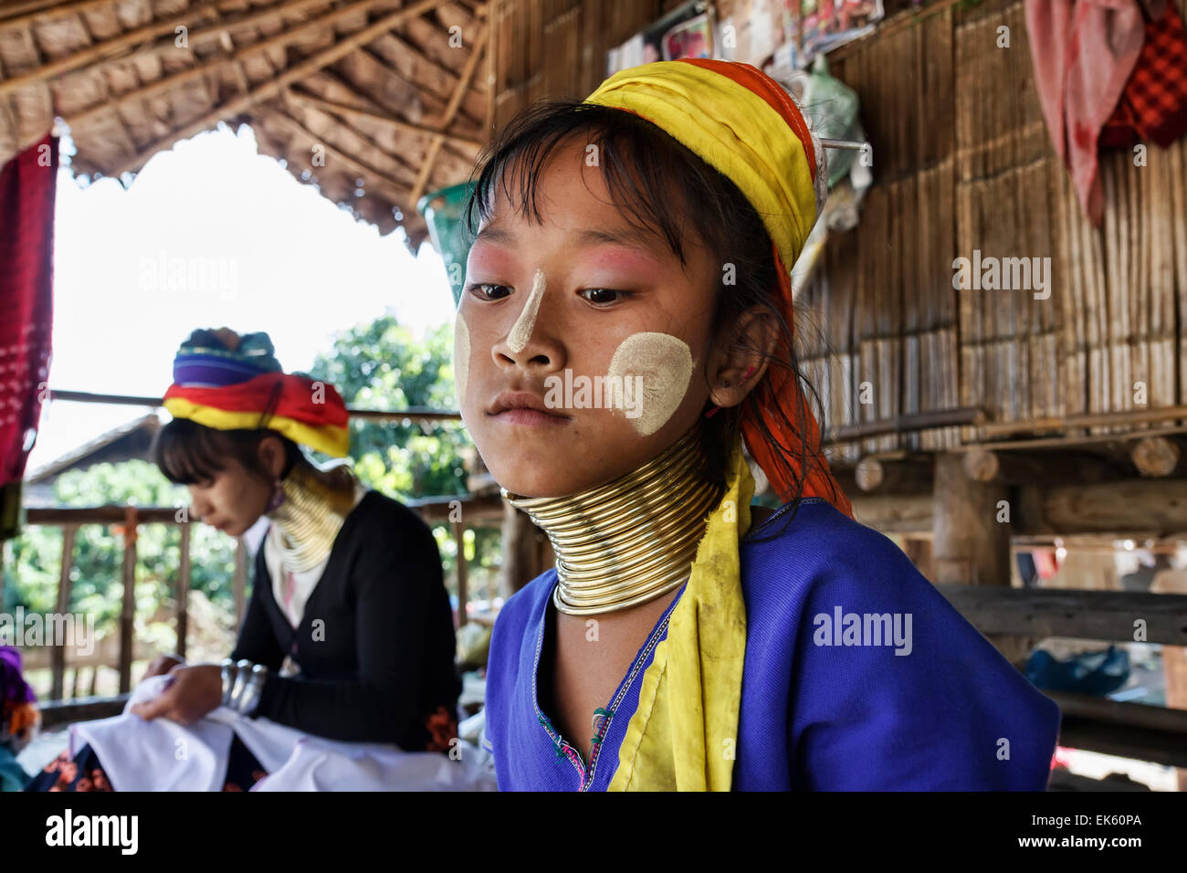 Thailand, Chang Mai, Karen Long Neck hill tribe village (Kayan Lahwi), young girl and her mother ...