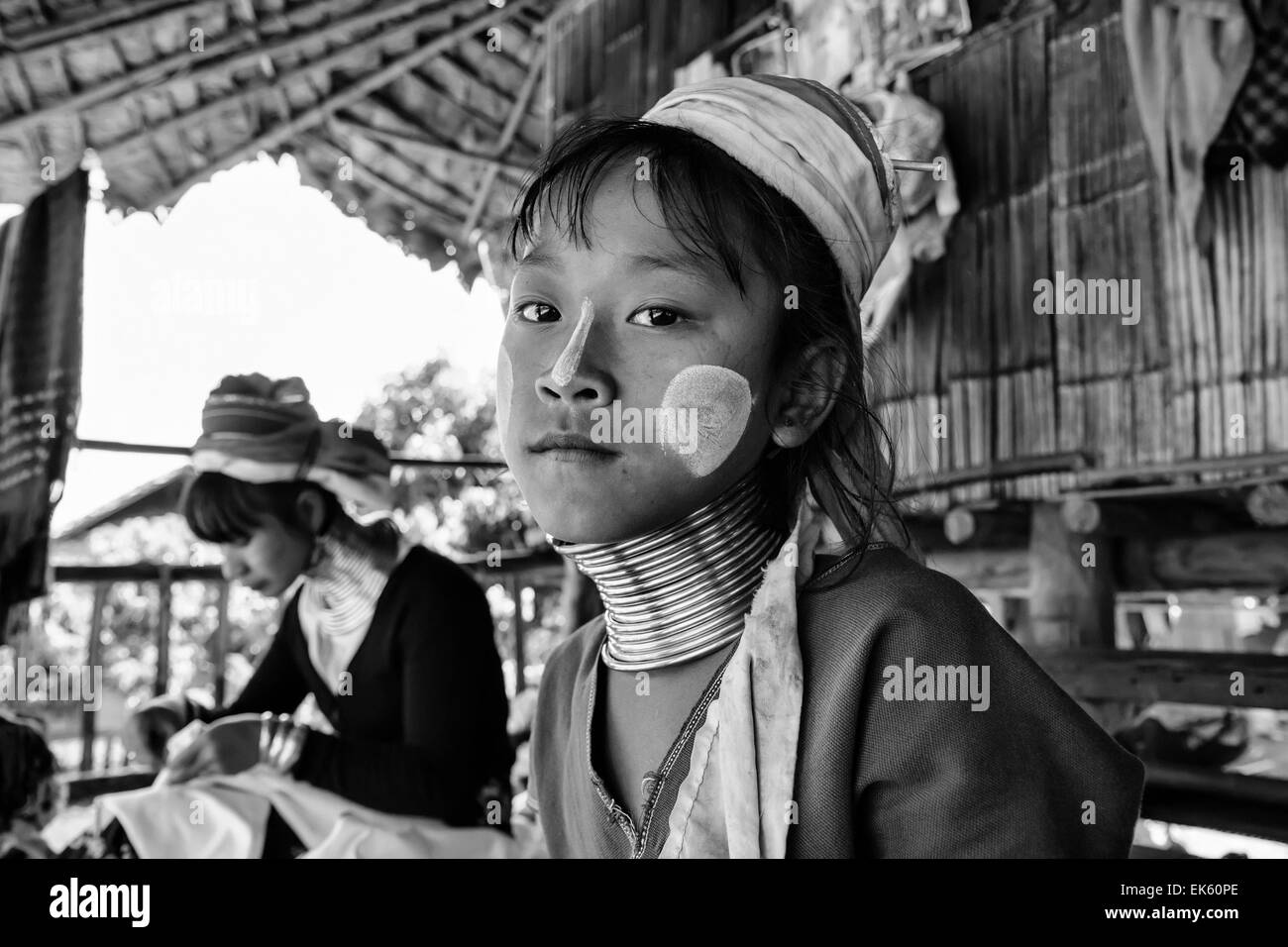 Thailand, Chang Mai, Karen Long Neck hill tribe village (Kayan Lahwi), young girl and her mother ...