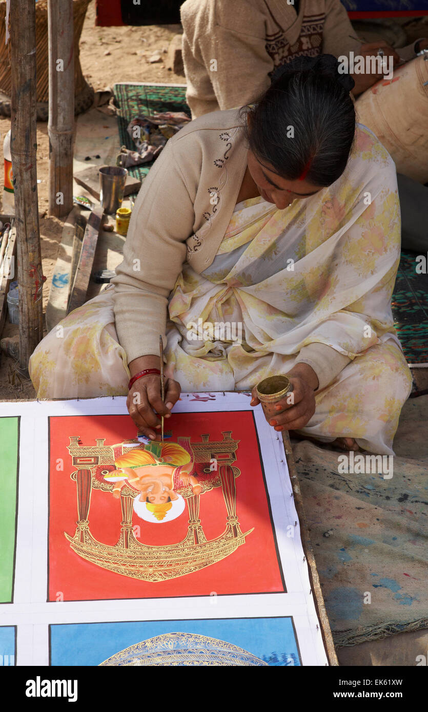 India, Rajasthan, Pushkar, indian woman painting an Hindu God drawing ...