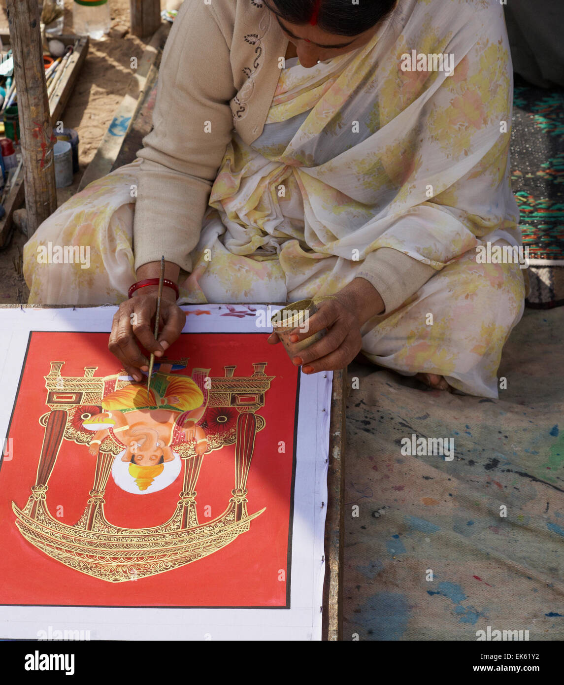 India, Rajasthan, Pushkar, indian woman painting an Hindu God drawing ...