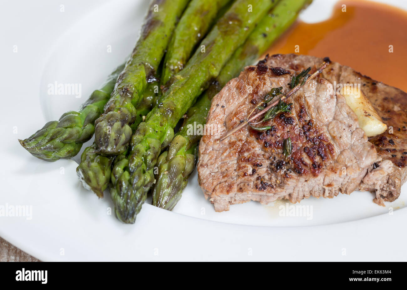 Green asparagus with beef steak and sauce Stock Photo - Alamy
