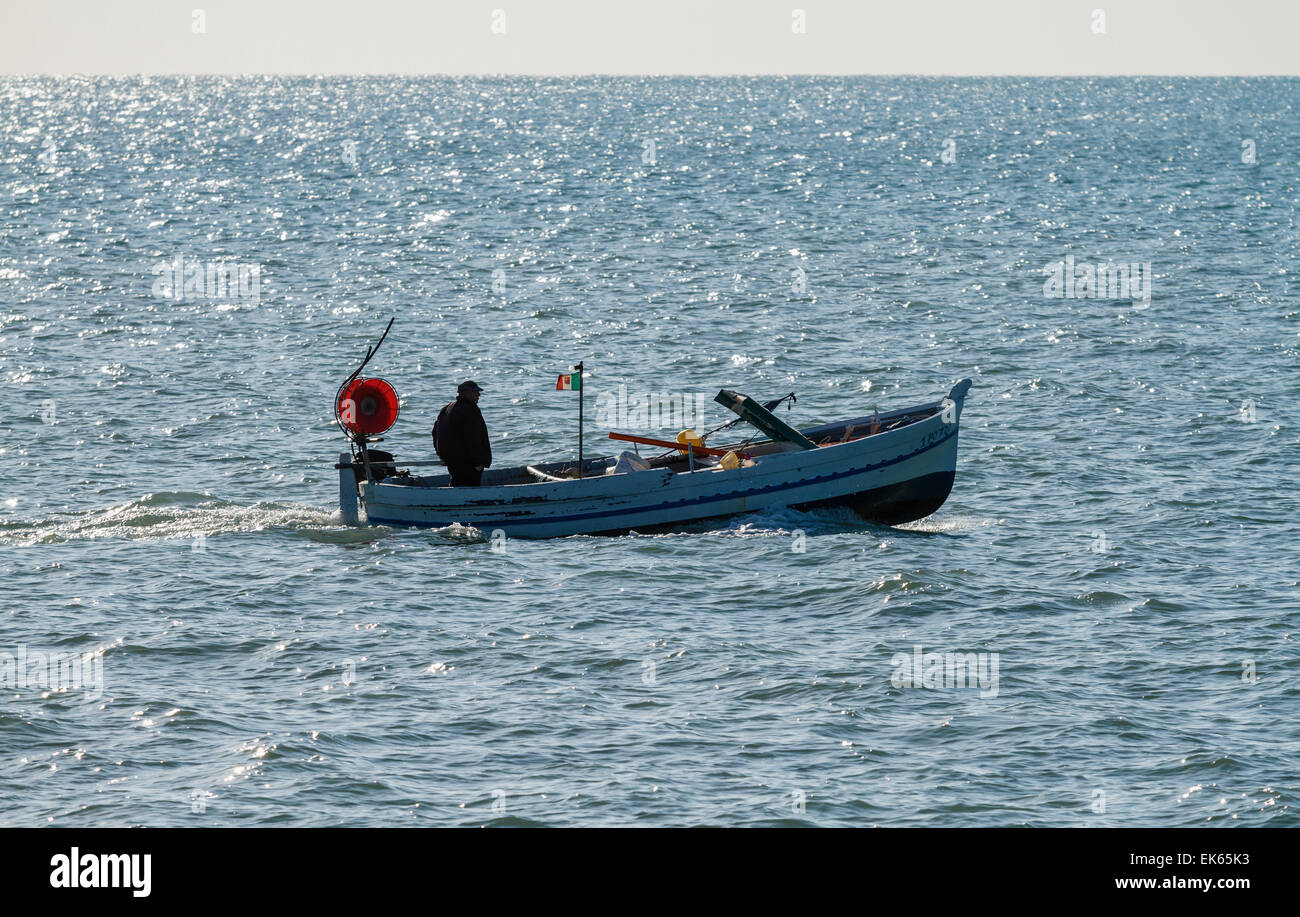 Italy, Sicily, Mediterranean Sea, fisherman on his wooden fishing boat ...