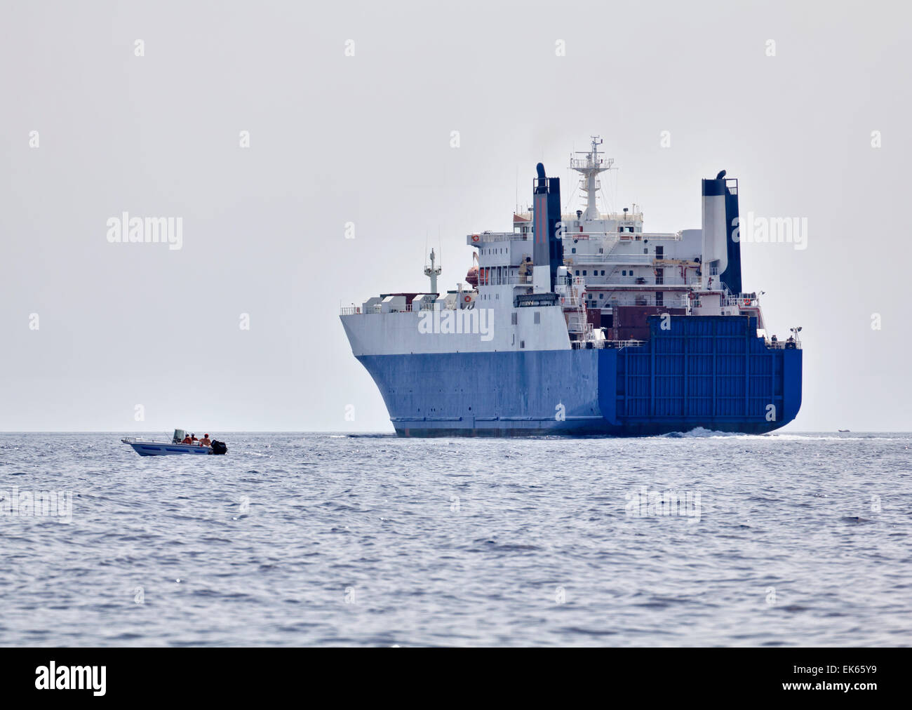Italy, Sicily, Mediterranean sea, Cargo ship and a fishermen's boat ...