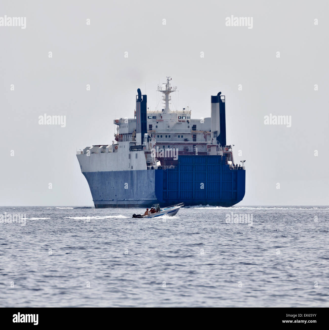 Italy, Sicily, Mediterranean sea, Cargo ship and a fishermen's boat ...