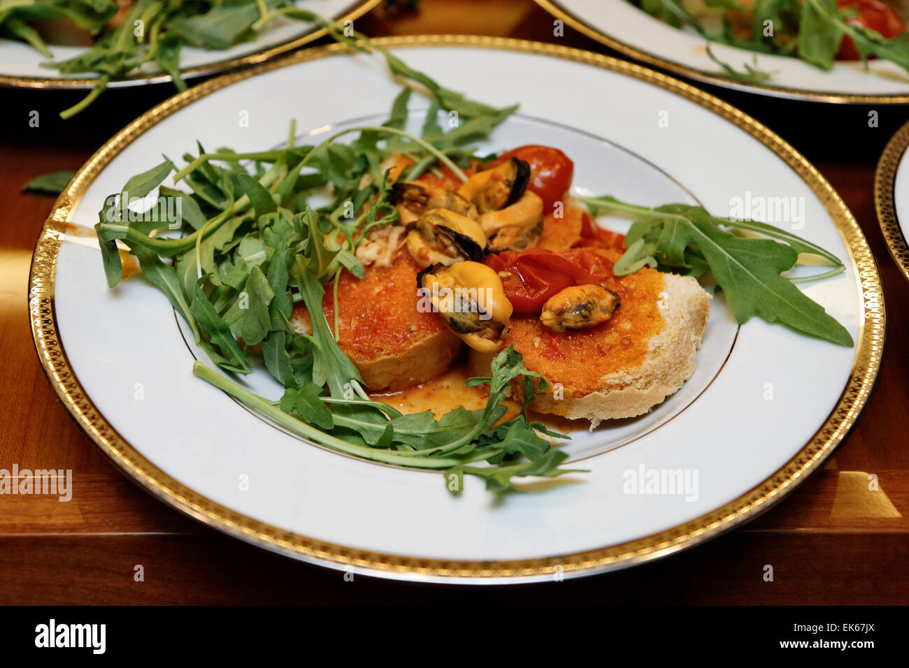 Italian appetizer with bread, garlic, mussels, tomatoes and garden ...