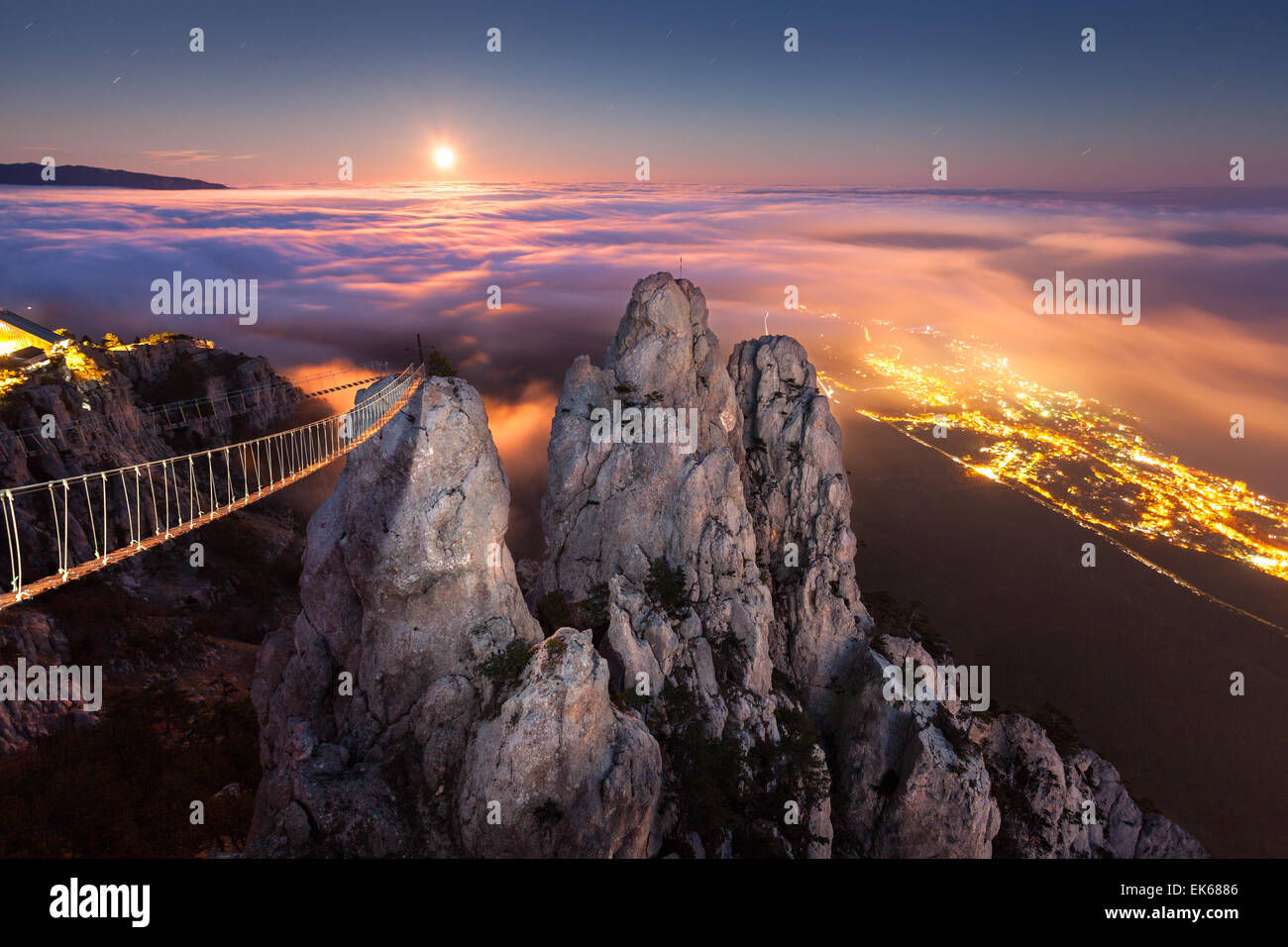 Beautiful night landscape with full moon, sea, rocks and clouds at ...