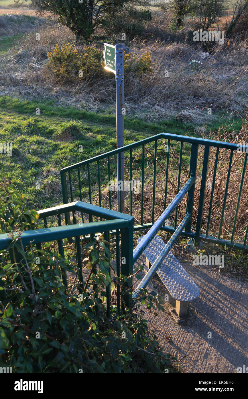 Footpath sign with metal railings and stile Stock Photo - Alamy