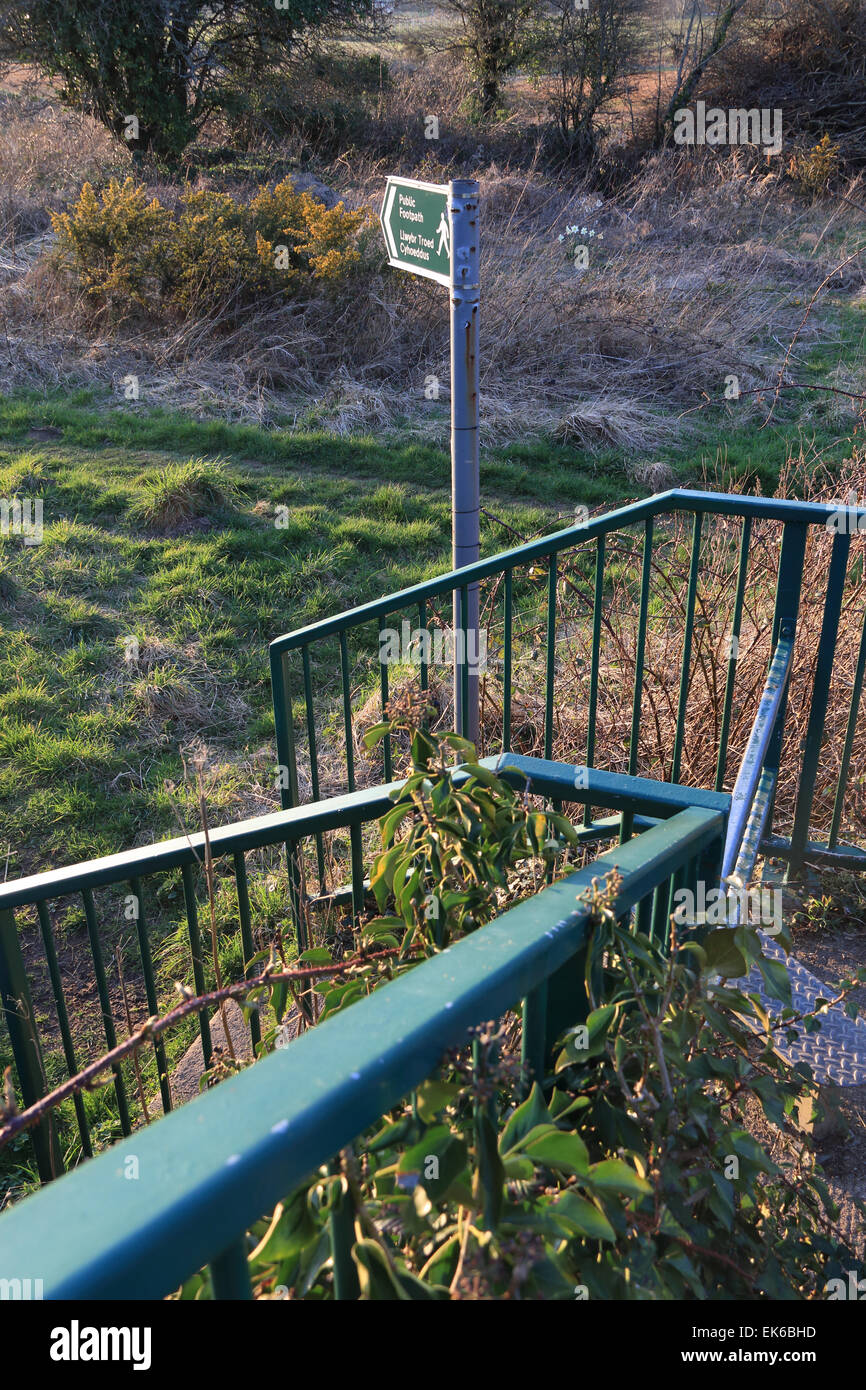 Footpath sign with metal railings and stile Stock Photo - Alamy