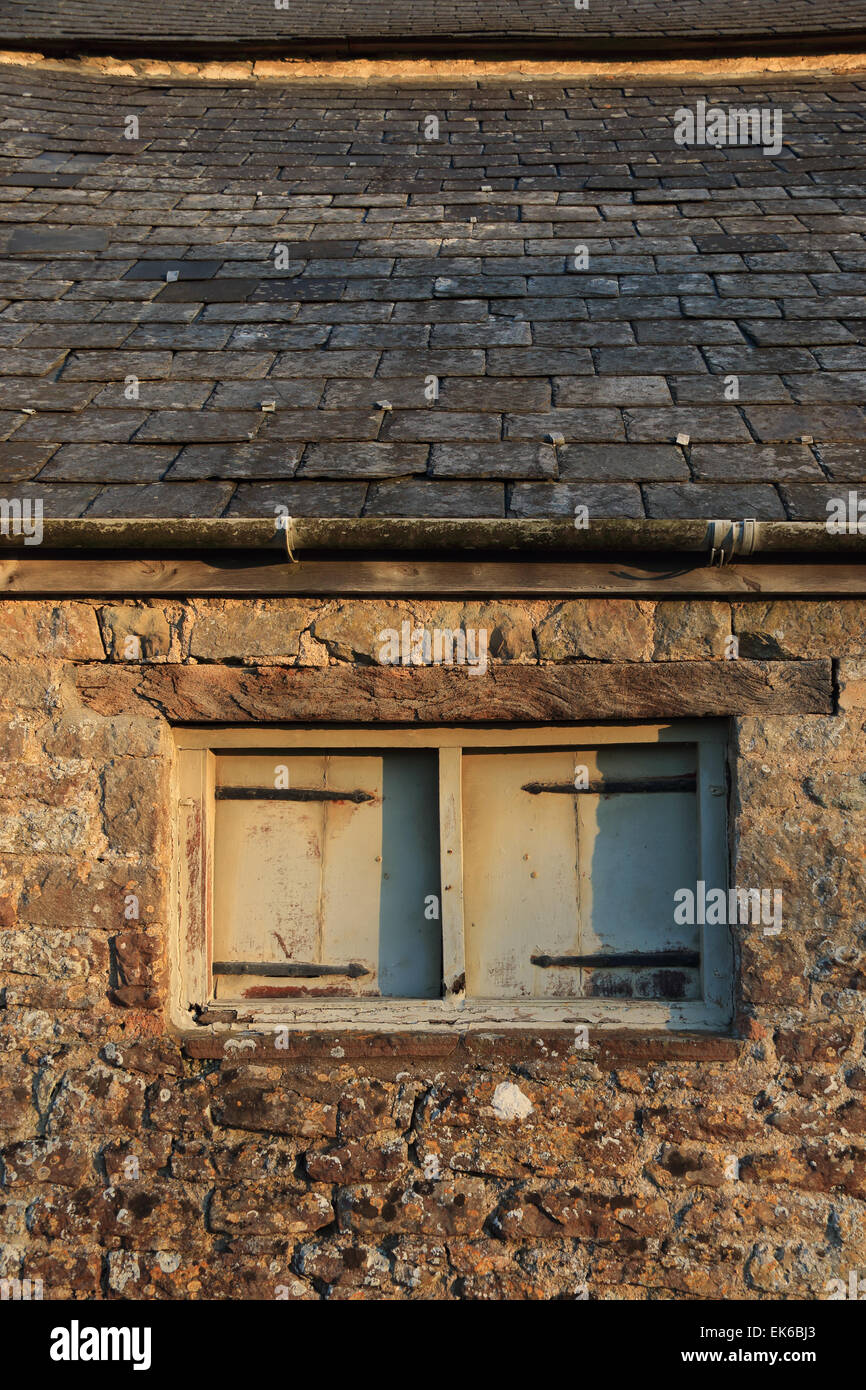 Old decaying window in barn with stone wall and slate roof Stock Photo ...
