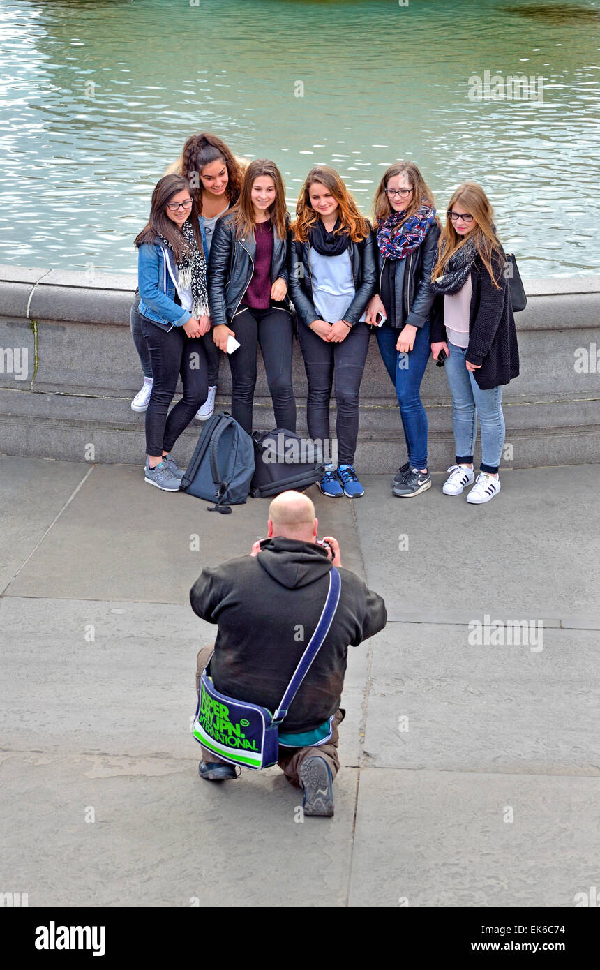 London, England, UK. Group of girls posing for a photo in Trafalgar ...