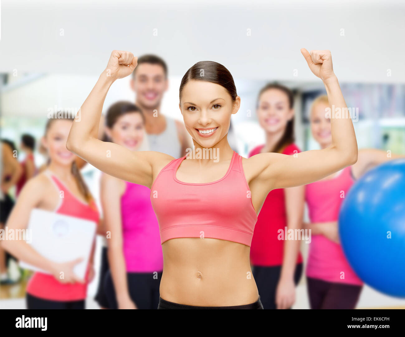 personal trainer with group in gym Stock Photo - Alamy