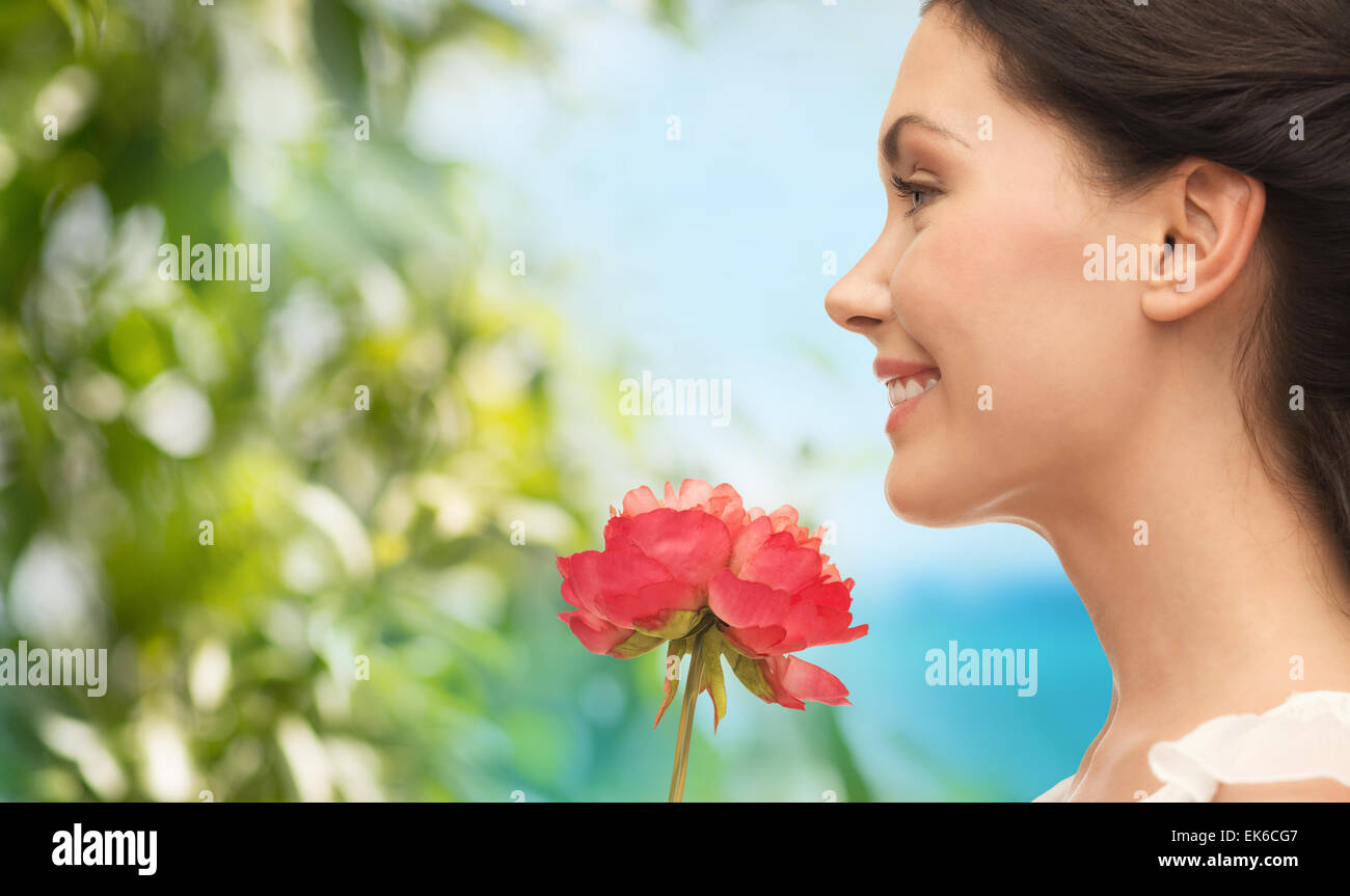 smiling woman smelling flower Stock Photo - Alamy
