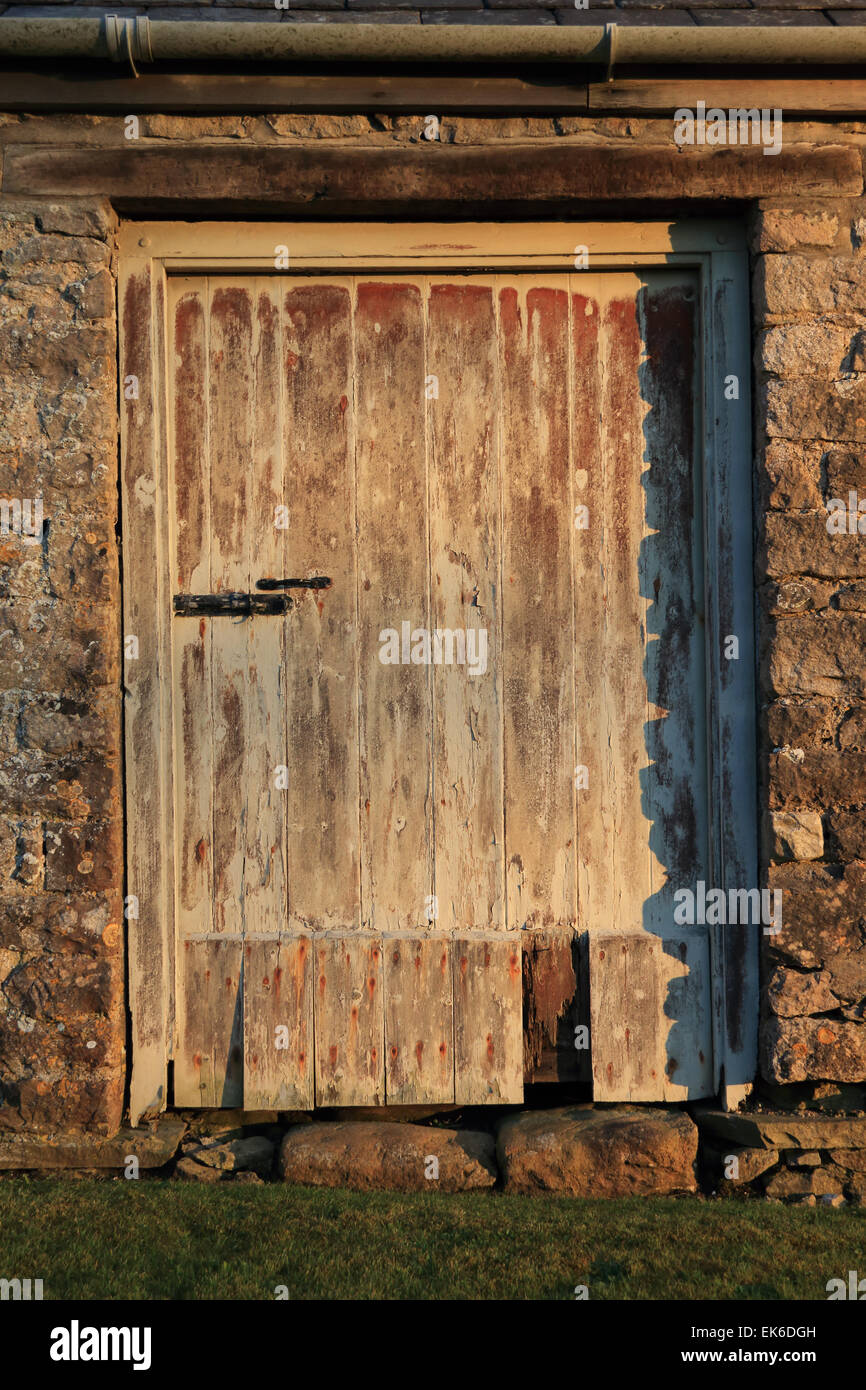 Old decaying barn door in stone wall Stock Photo - Alamy