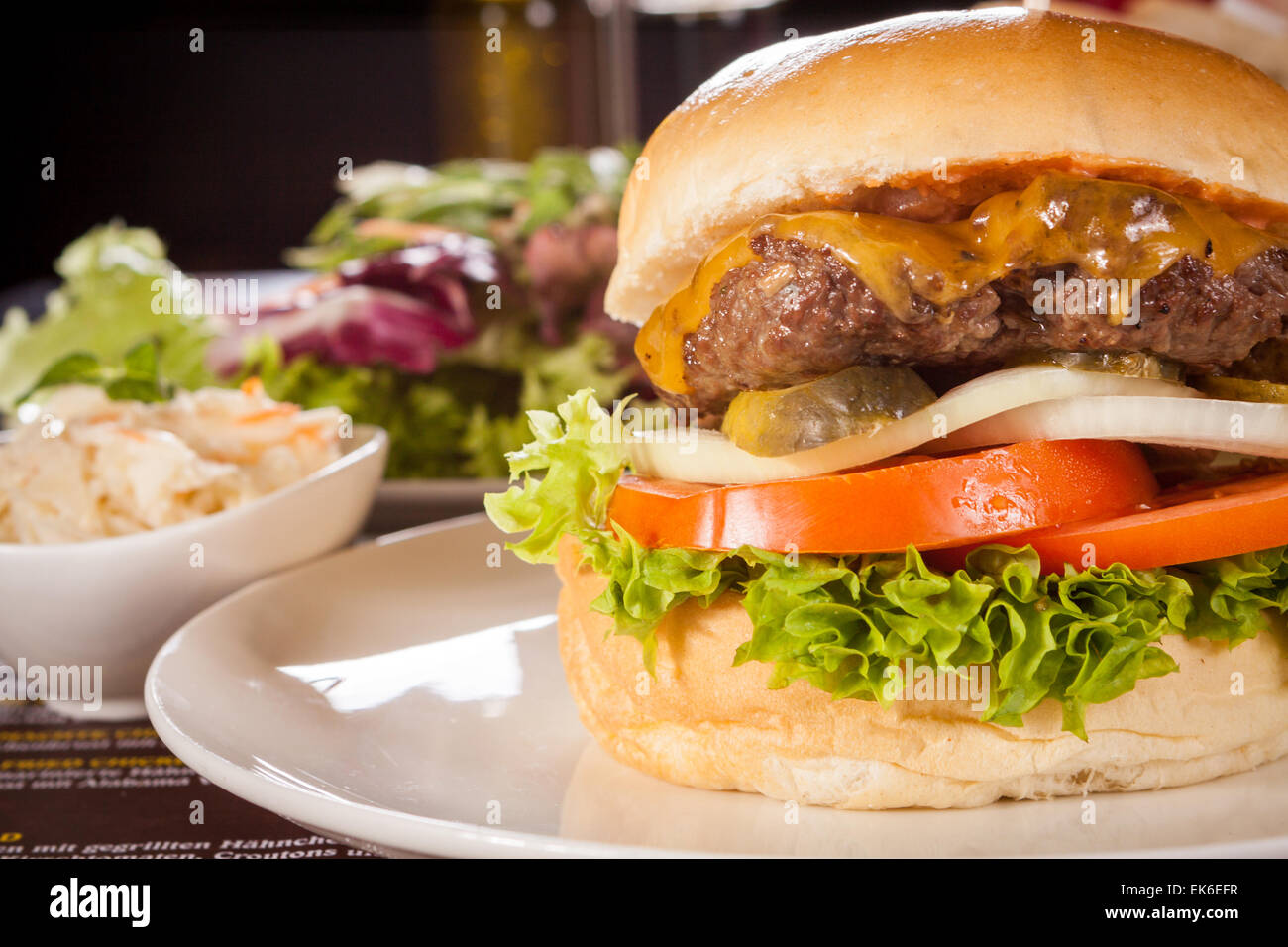 Tasty traditional cheeseburger with a ground beef patty topped with ...