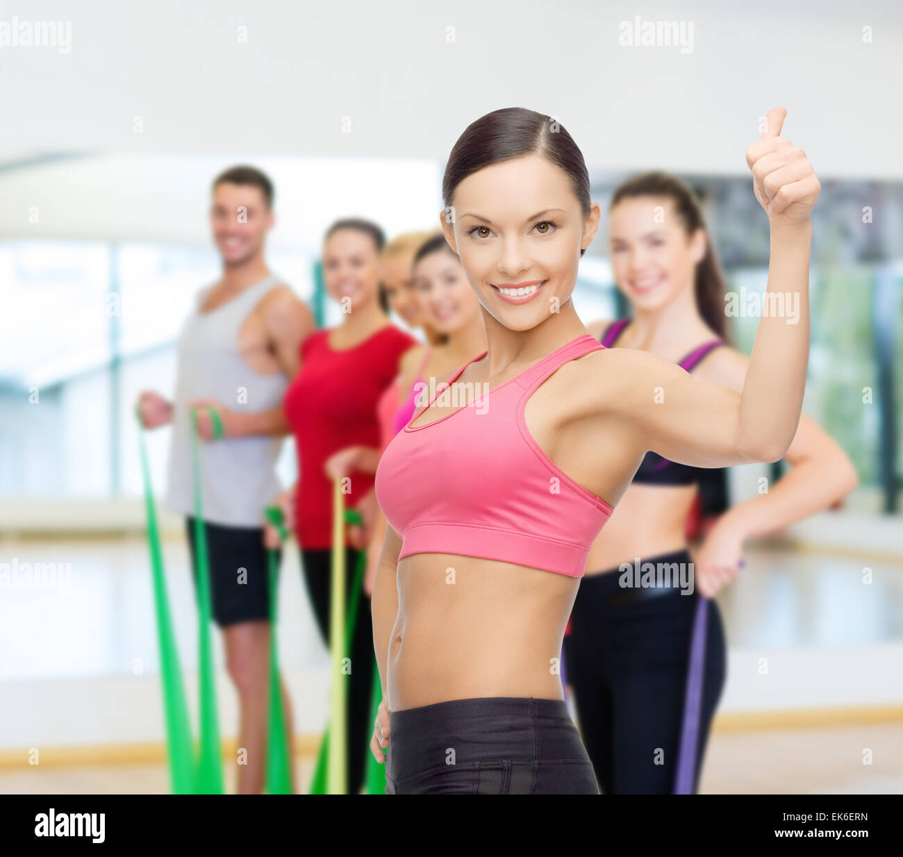 personal trainer with group in gym Stock Photo - Alamy