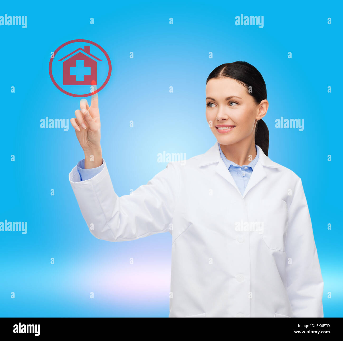 smiling female doctor pointing to hospital sign Stock Photo - Alamy