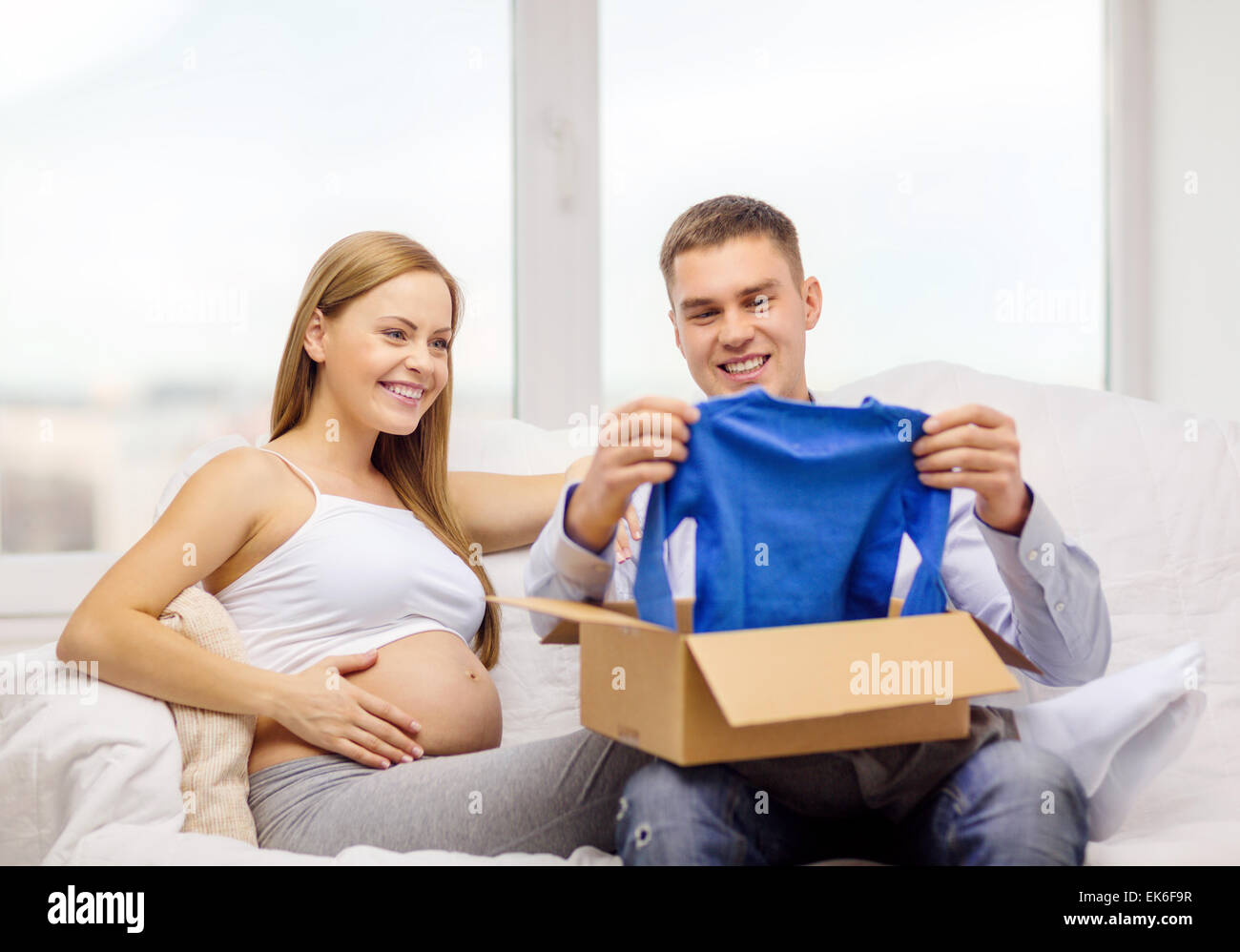 happy family expecting child opening parcel box Stock Photo - Alamy