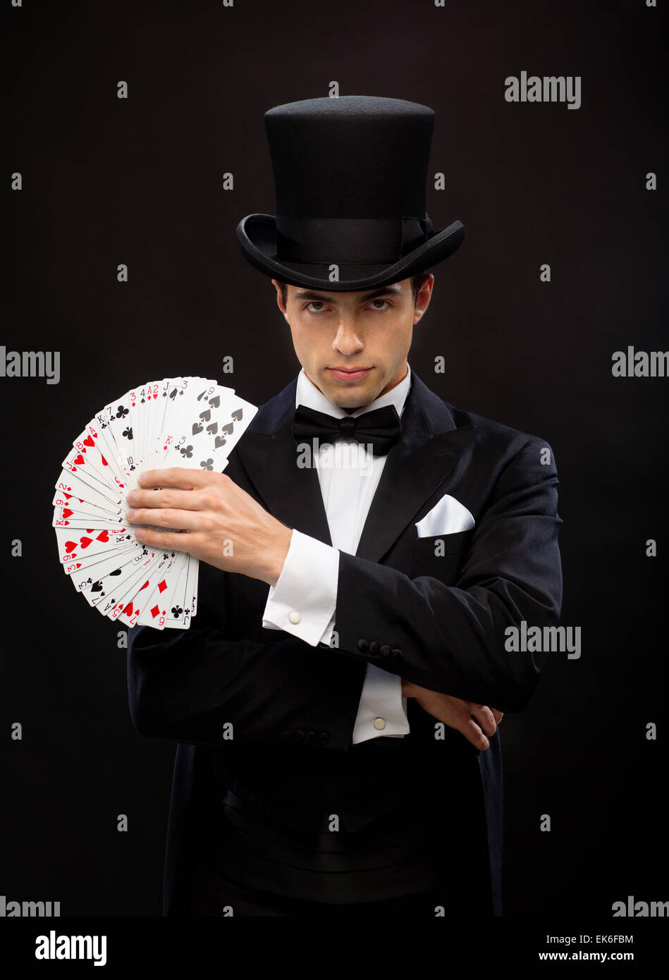 magician showing trick with playing cards Stock Photo - Alamy