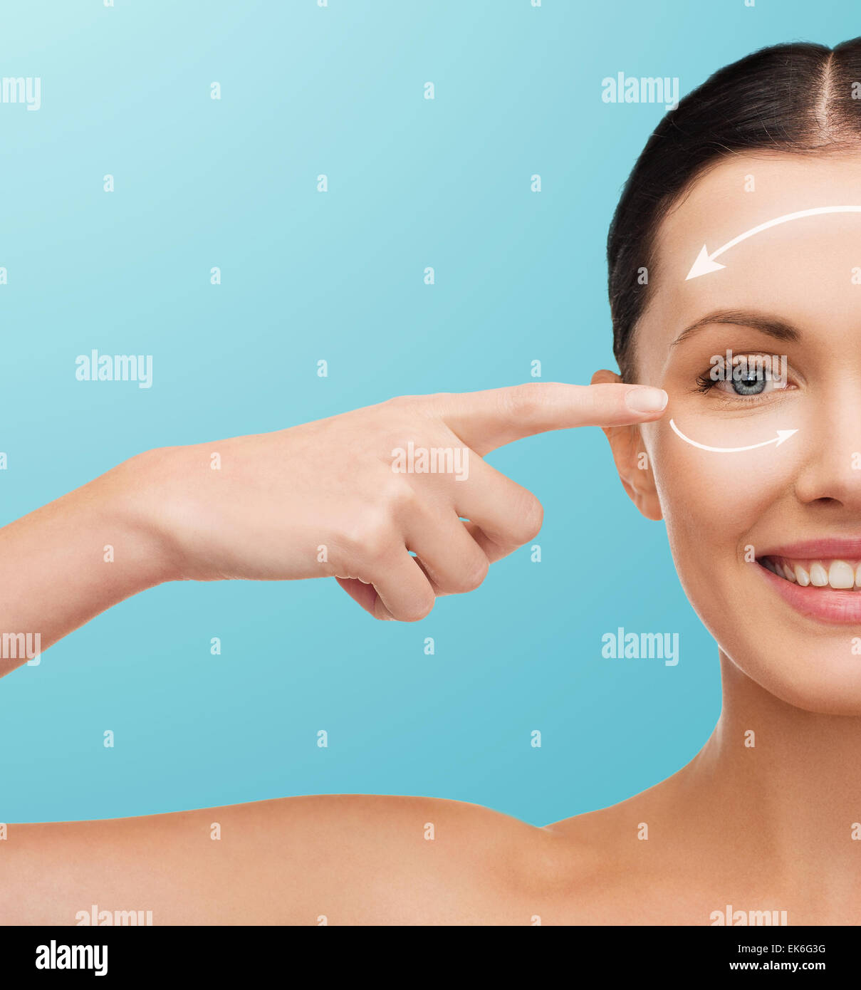 young calm woman pointing to her eye Stock Photo - Alamy