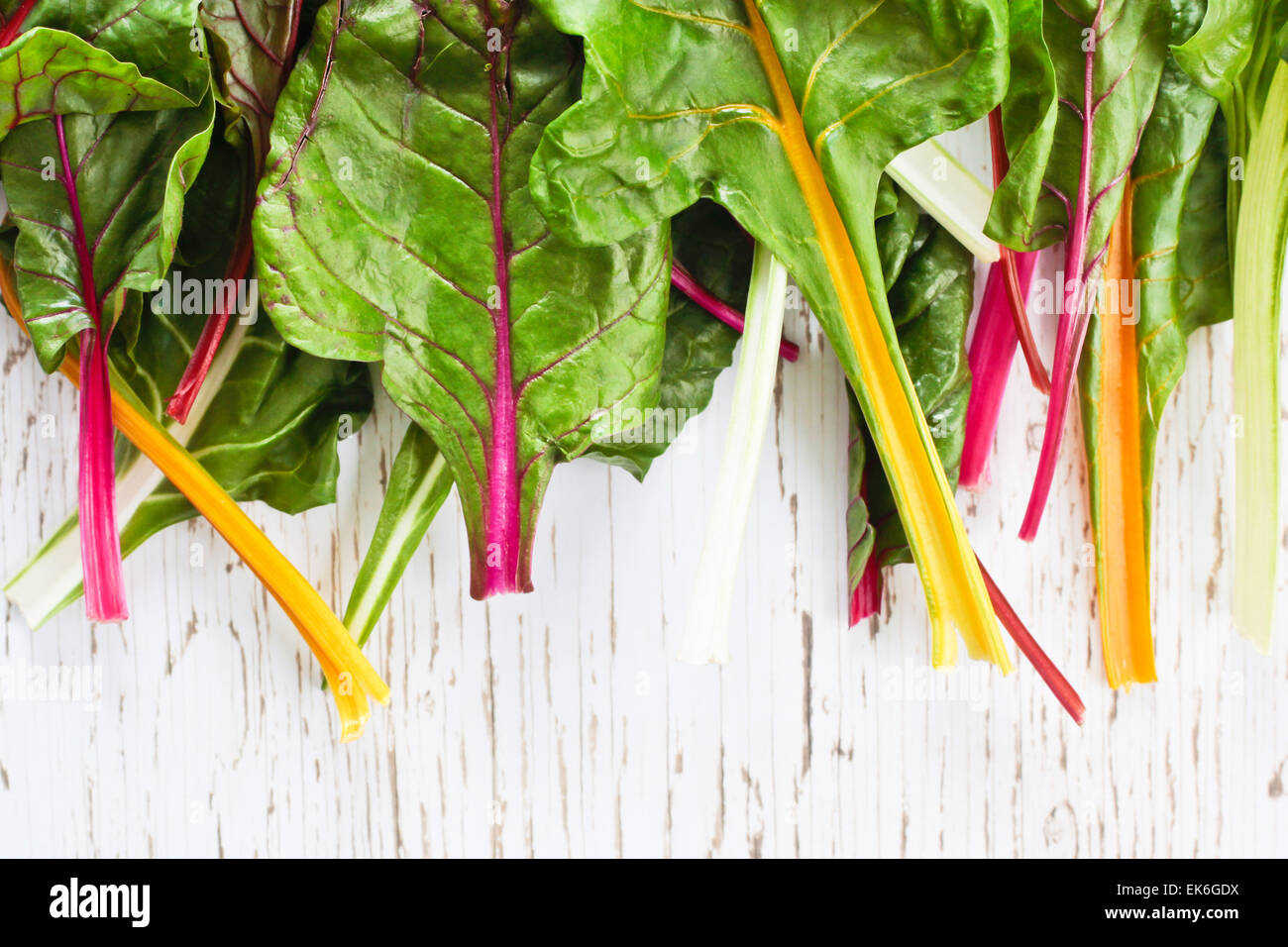 Stalks of rainbow chard leaves on a wooden surface Stock Photo - Alamy